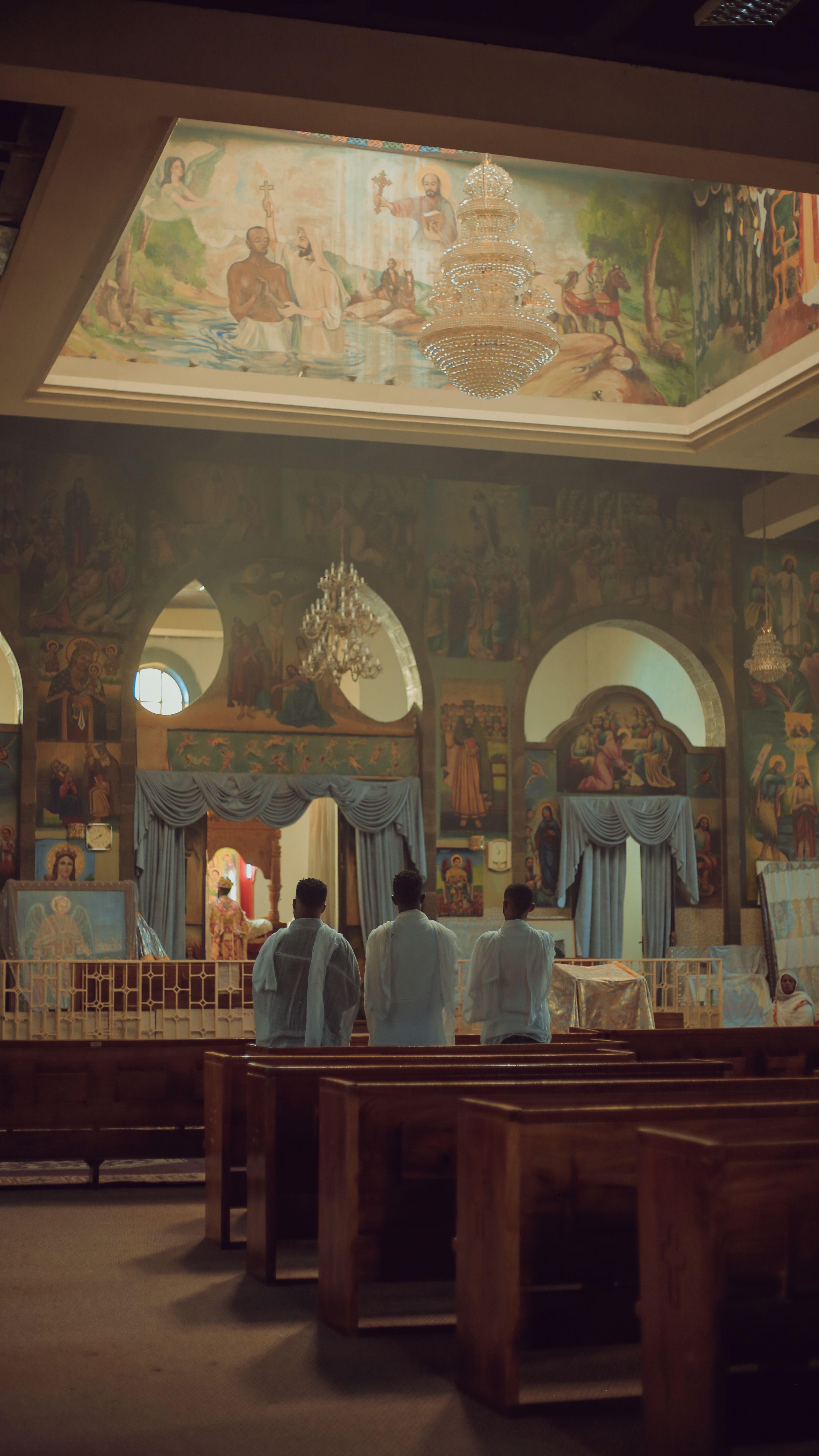 Priests Standing in a Church with Paintings on the Walls · Free Stock Photo