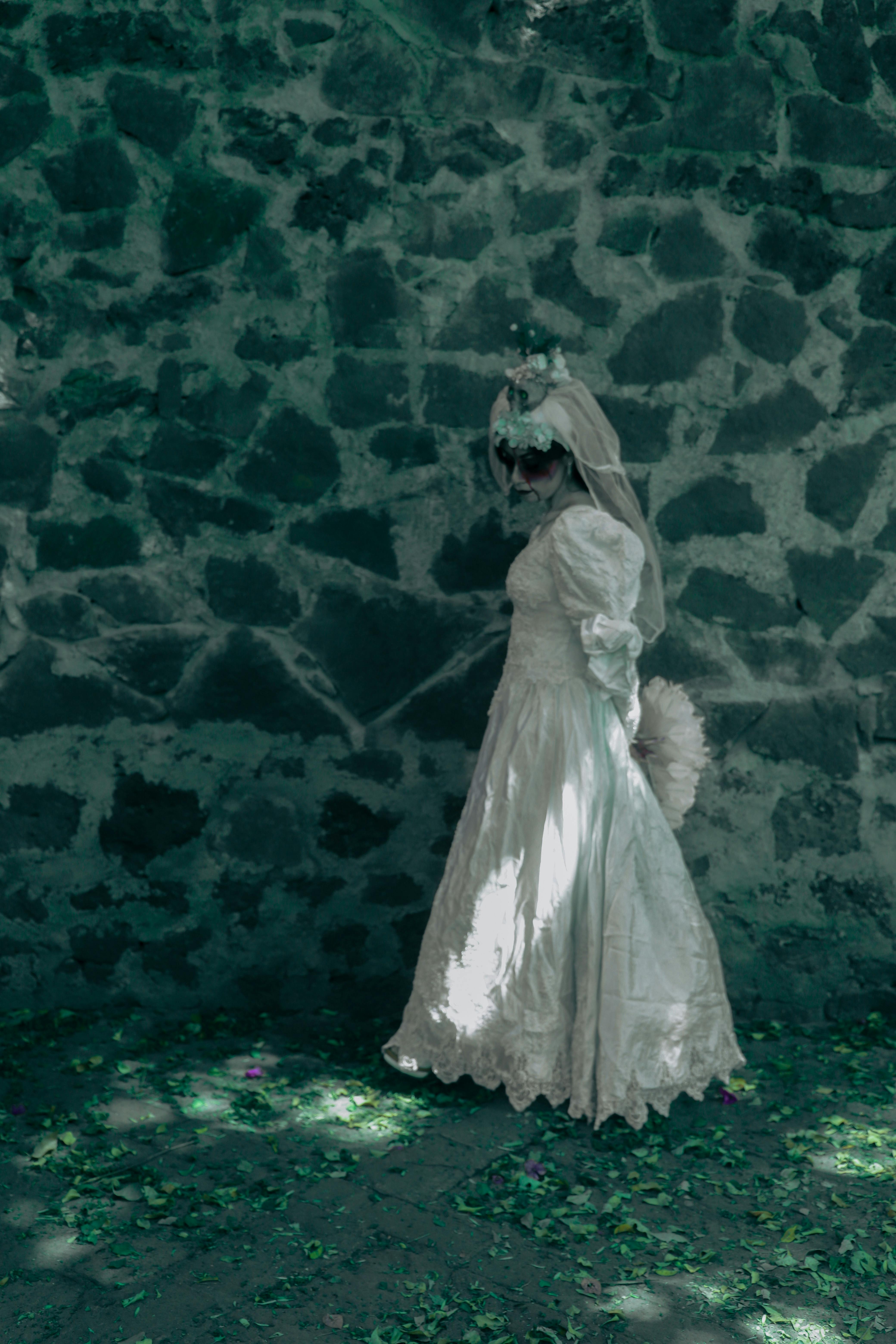 Woman in a Costume and a Crown with Old Yellow Book Pages Flying Around ...