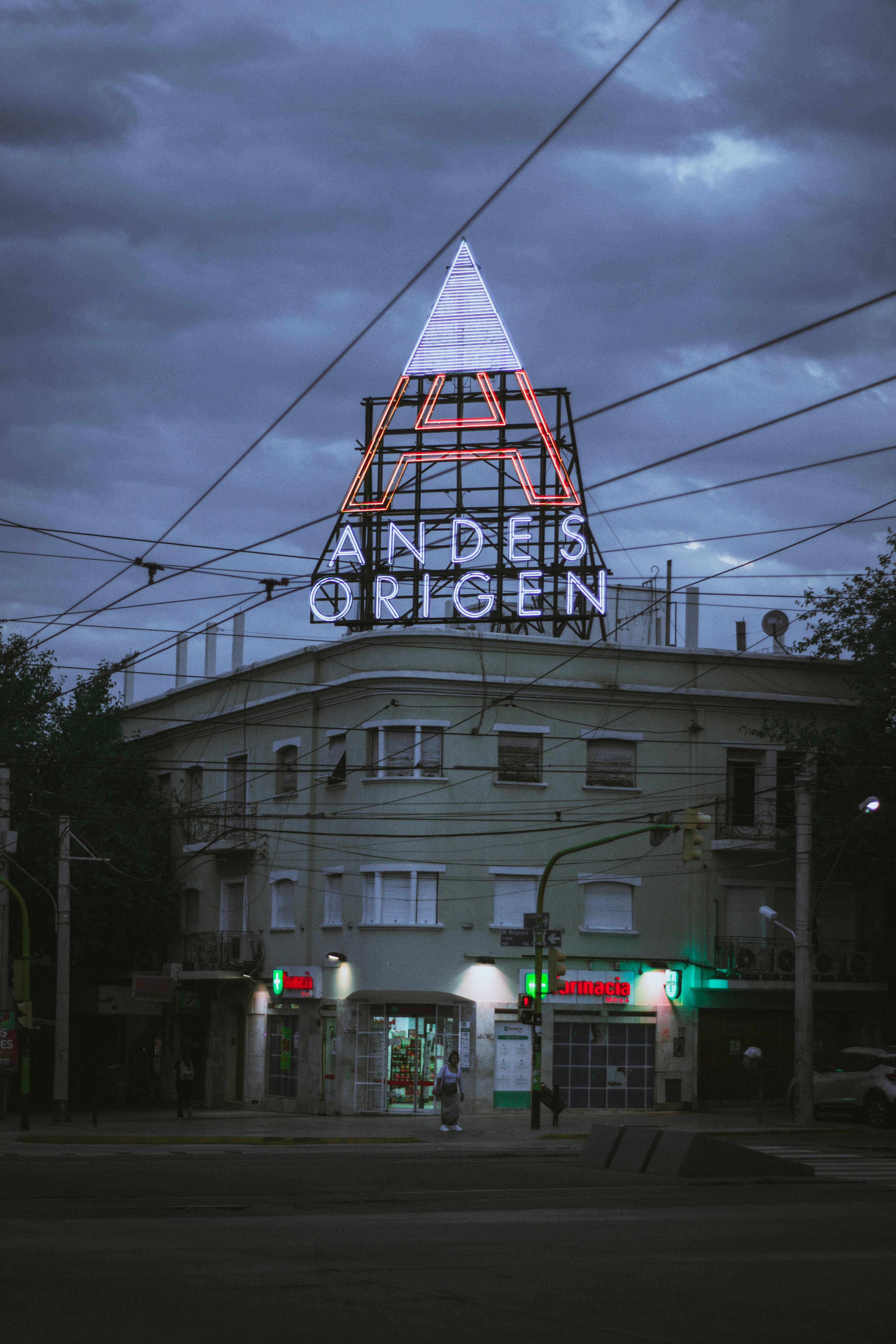 Building with Andes Origen Neon Sign · Free Stock Photo
