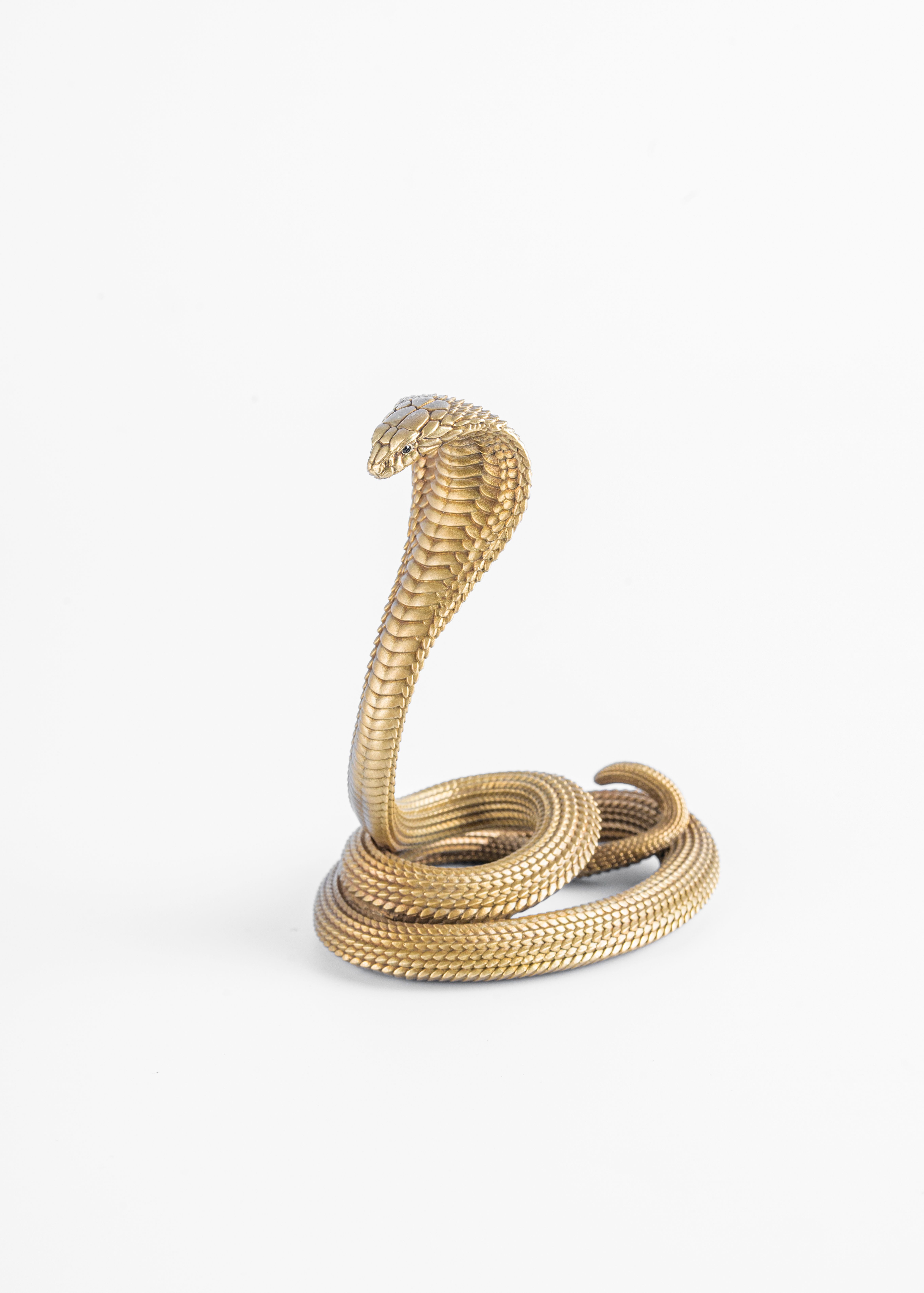 A Handmade, Golden Cobra Phone Stand · Free Stock Photo