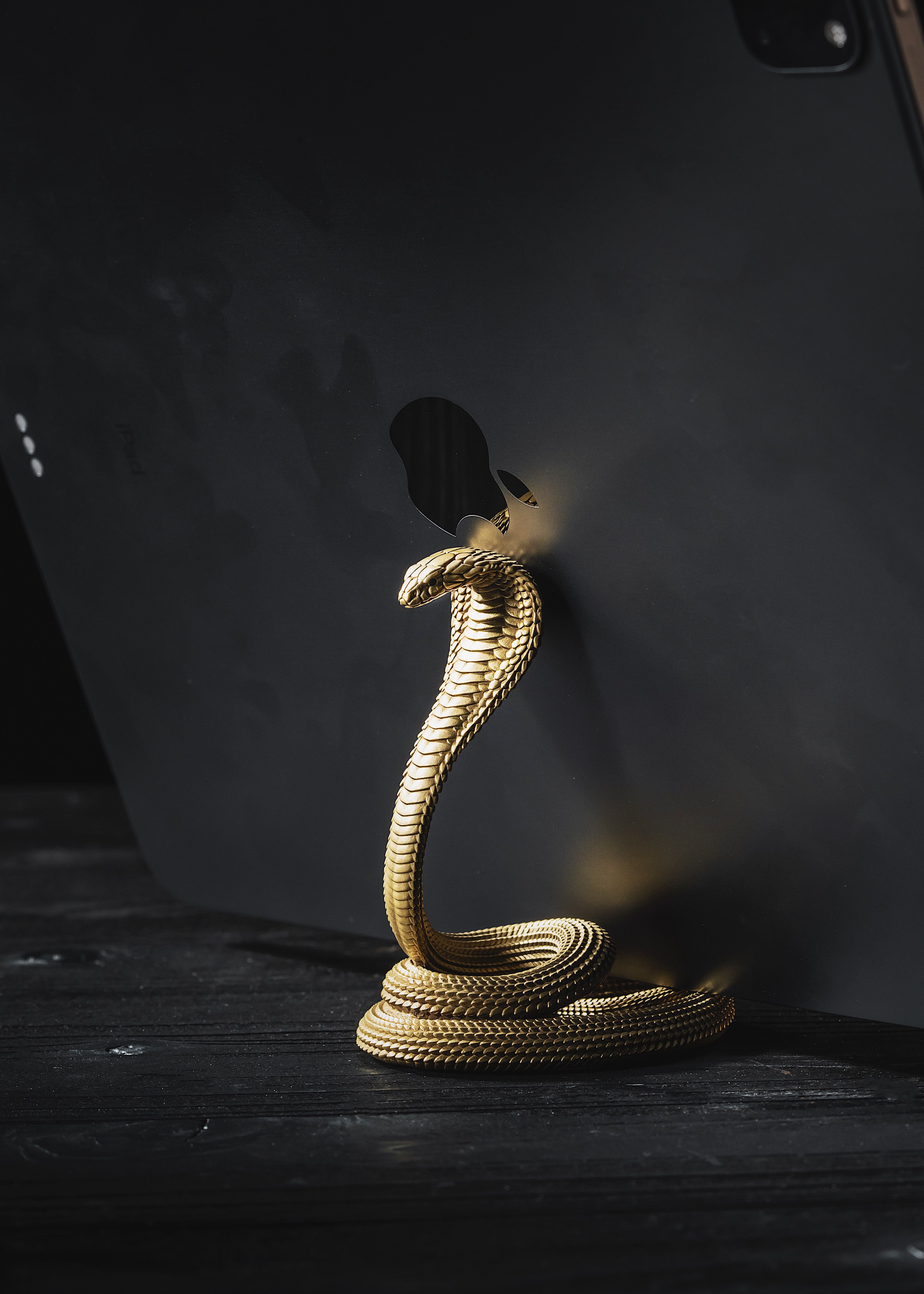 A Tablet Standing on a Golden Cobra Stand · Free Stock Photo
