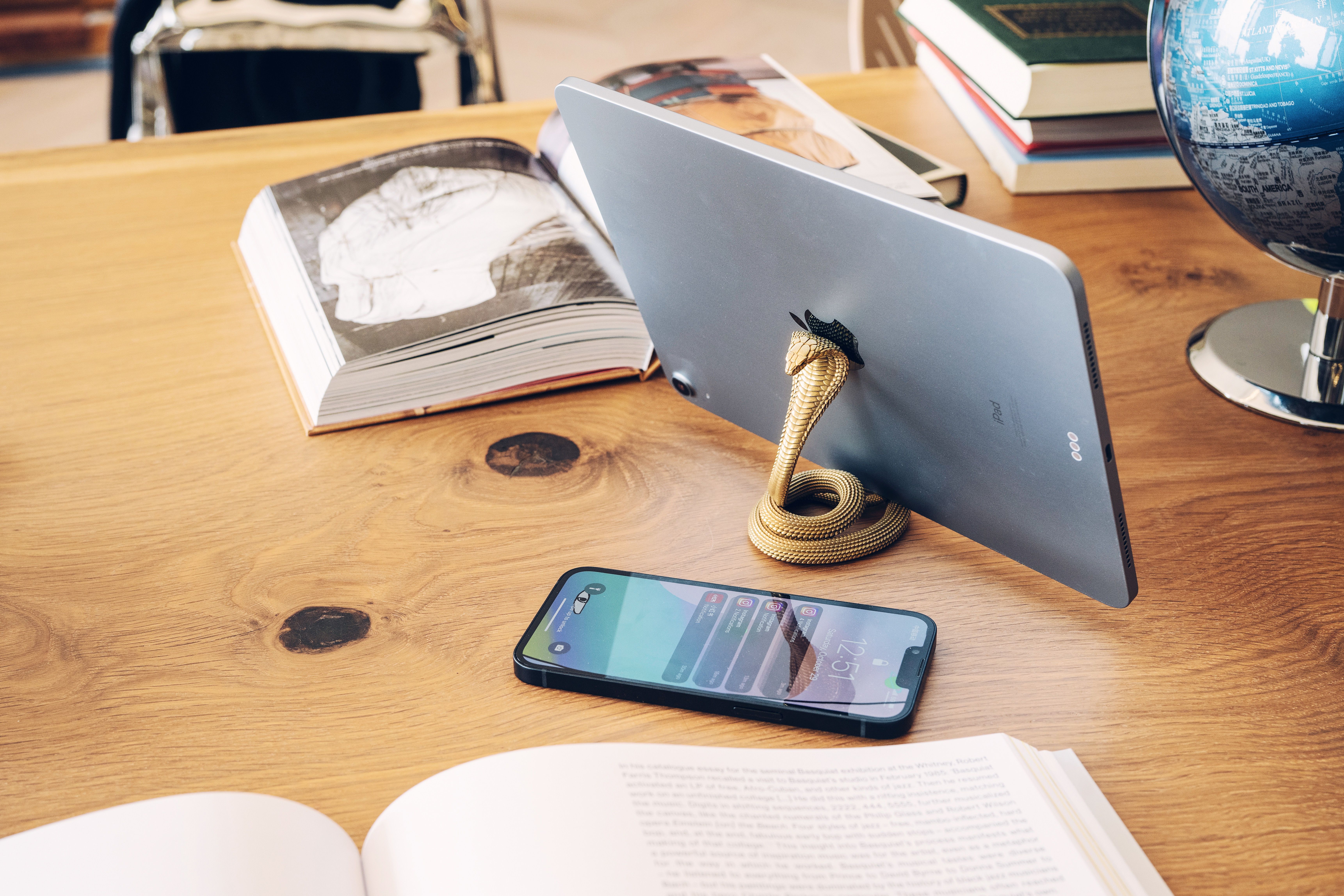 Snake Figurine Holding Tablet on Desk · Free Stock Photo