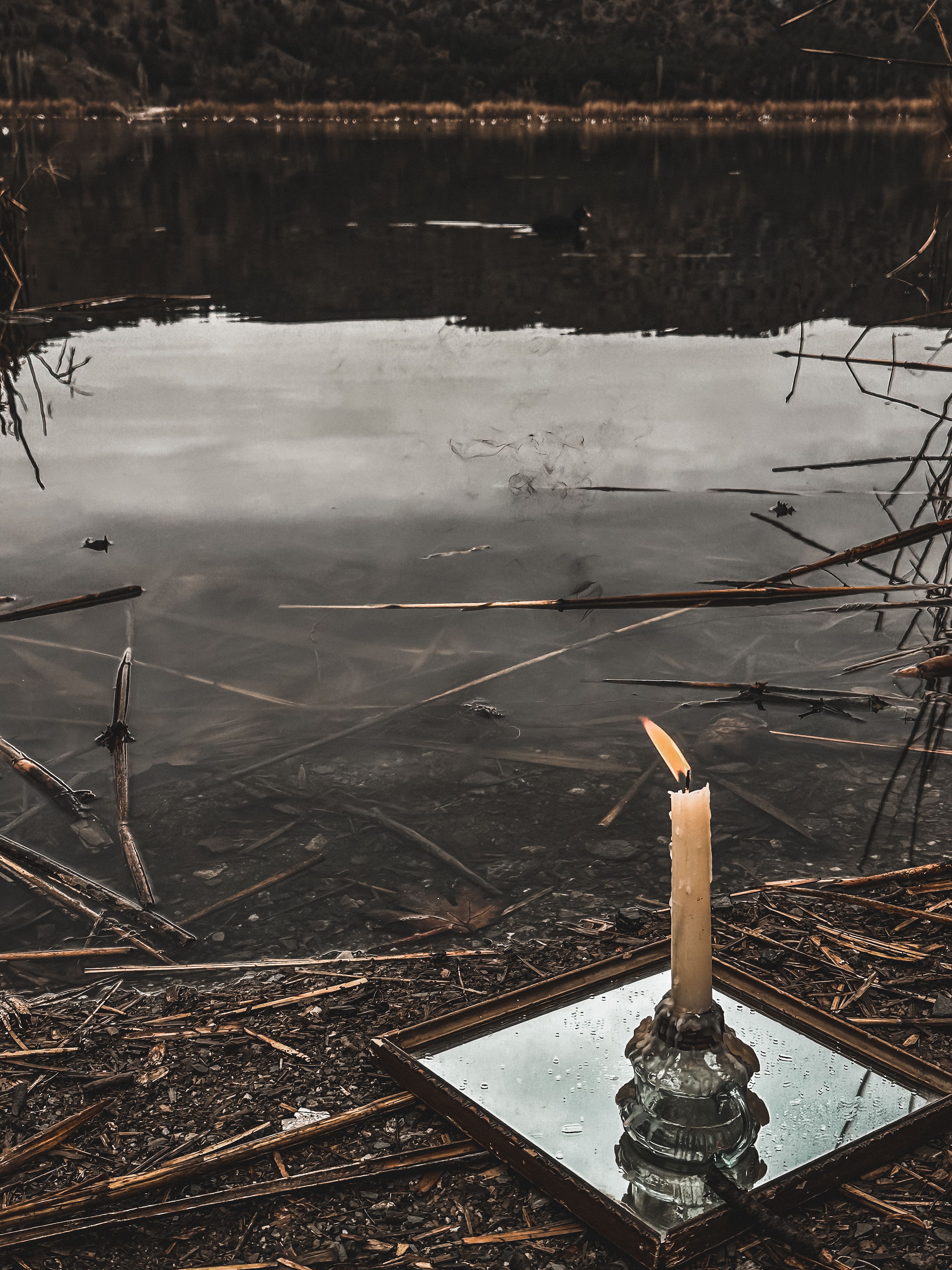 Wax Candle on Mirror on Lakeshore · Free Stock Photo