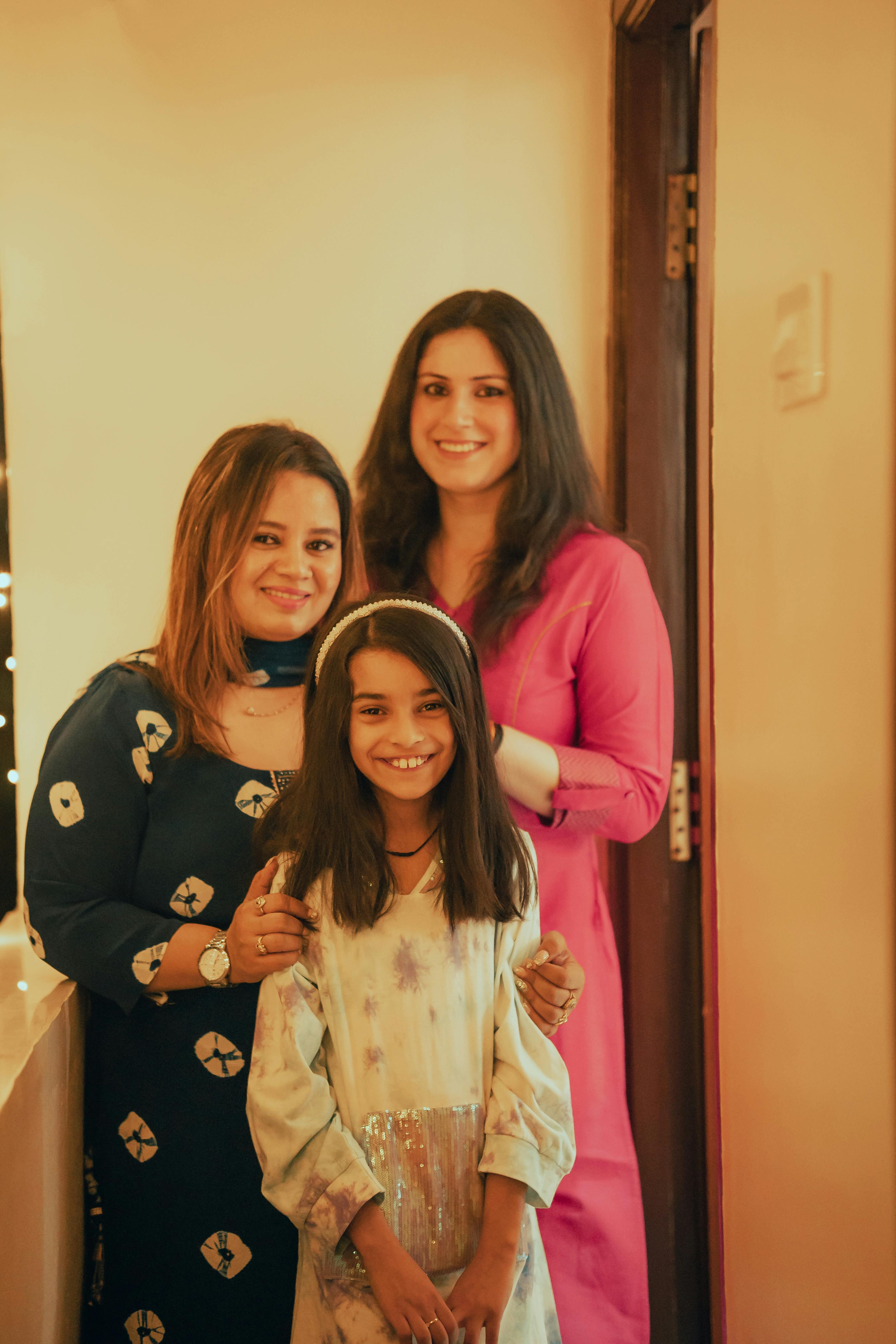 Two Women Standing Outside, Holding Hands and Smiling · Free Stock Photo