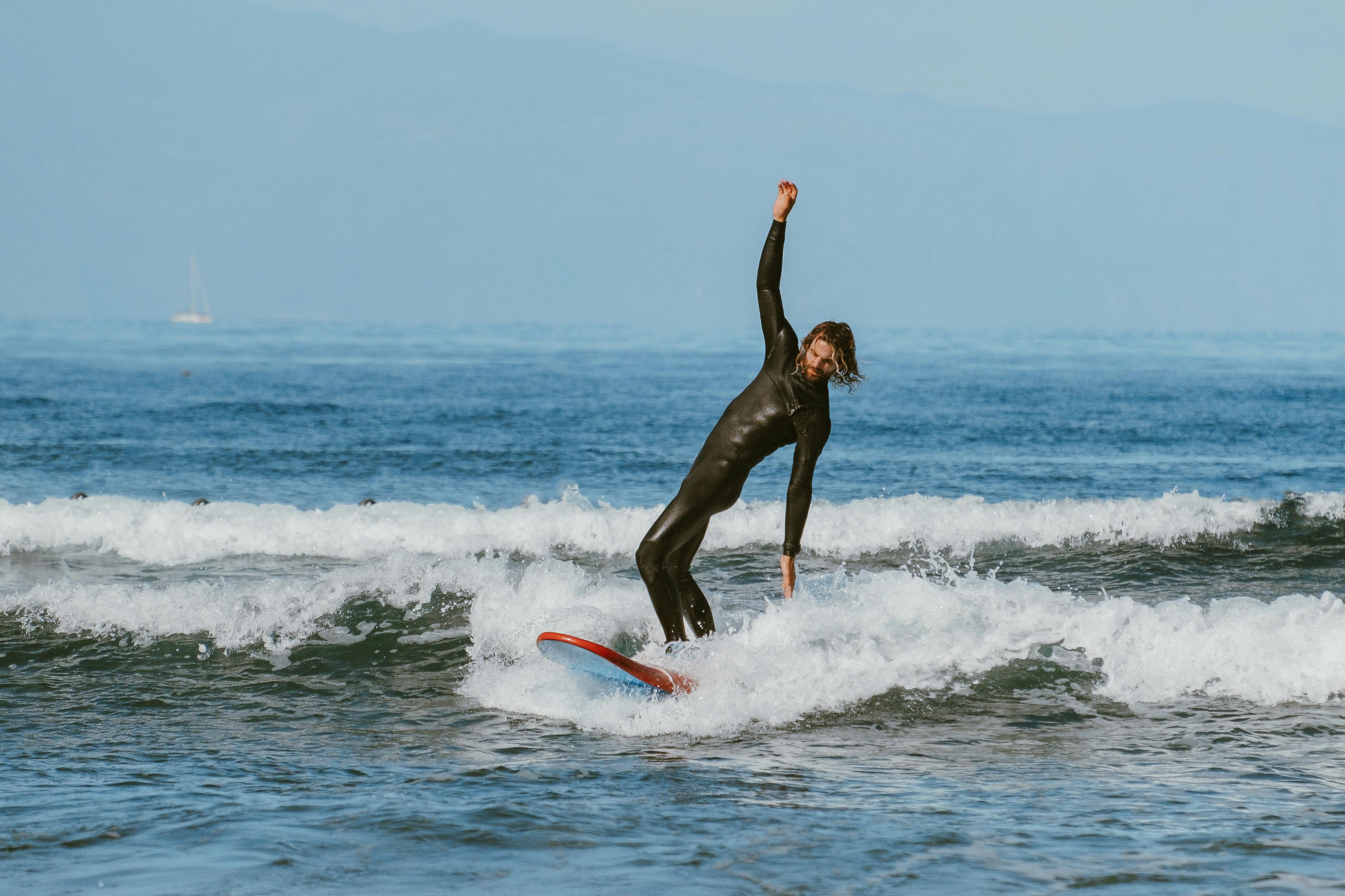 Man Surfing on Sea Shore · Free Stock Photo
