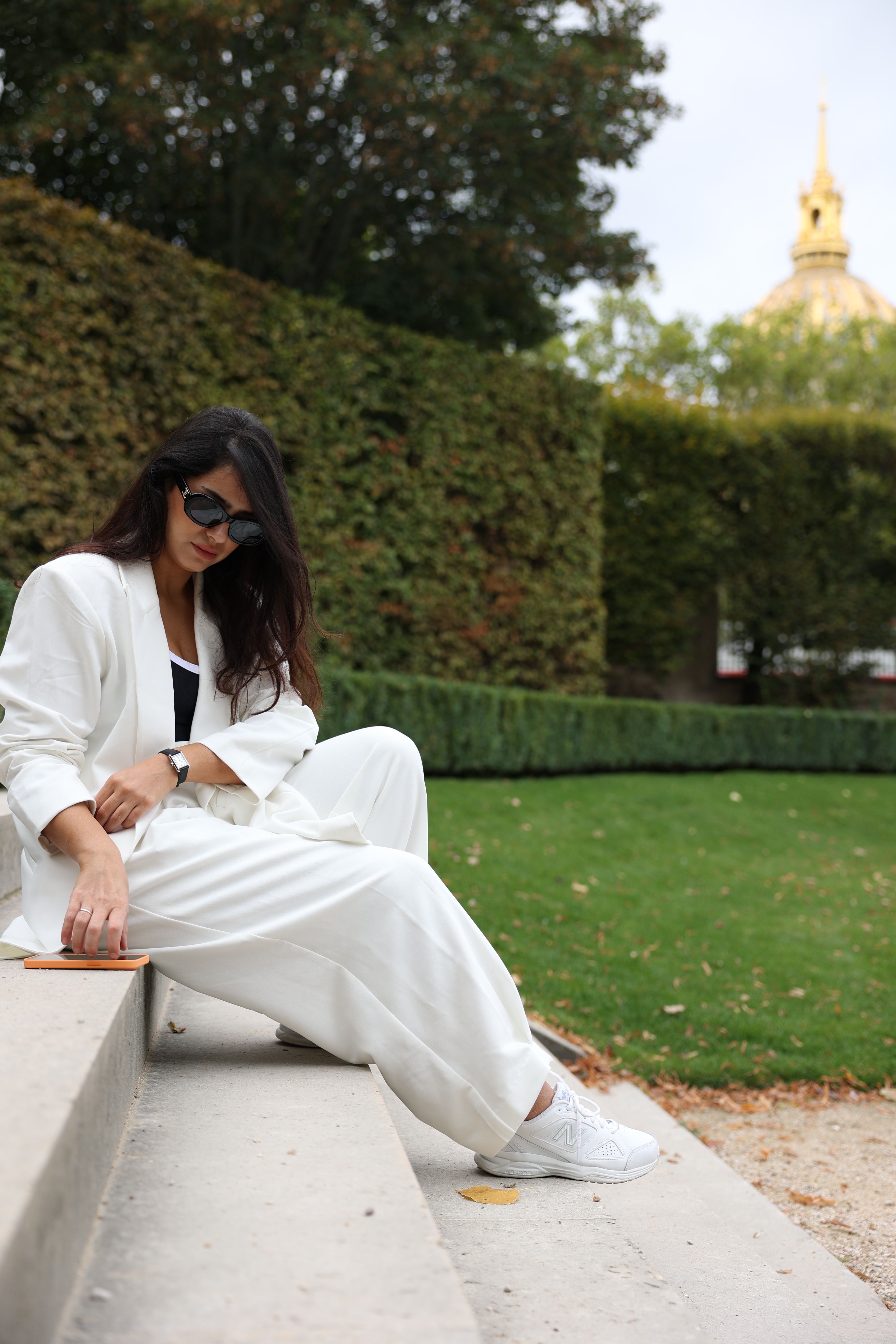 Young Woman in a White Elegant Outfit Sitting on Steps · Free Stock Photo
