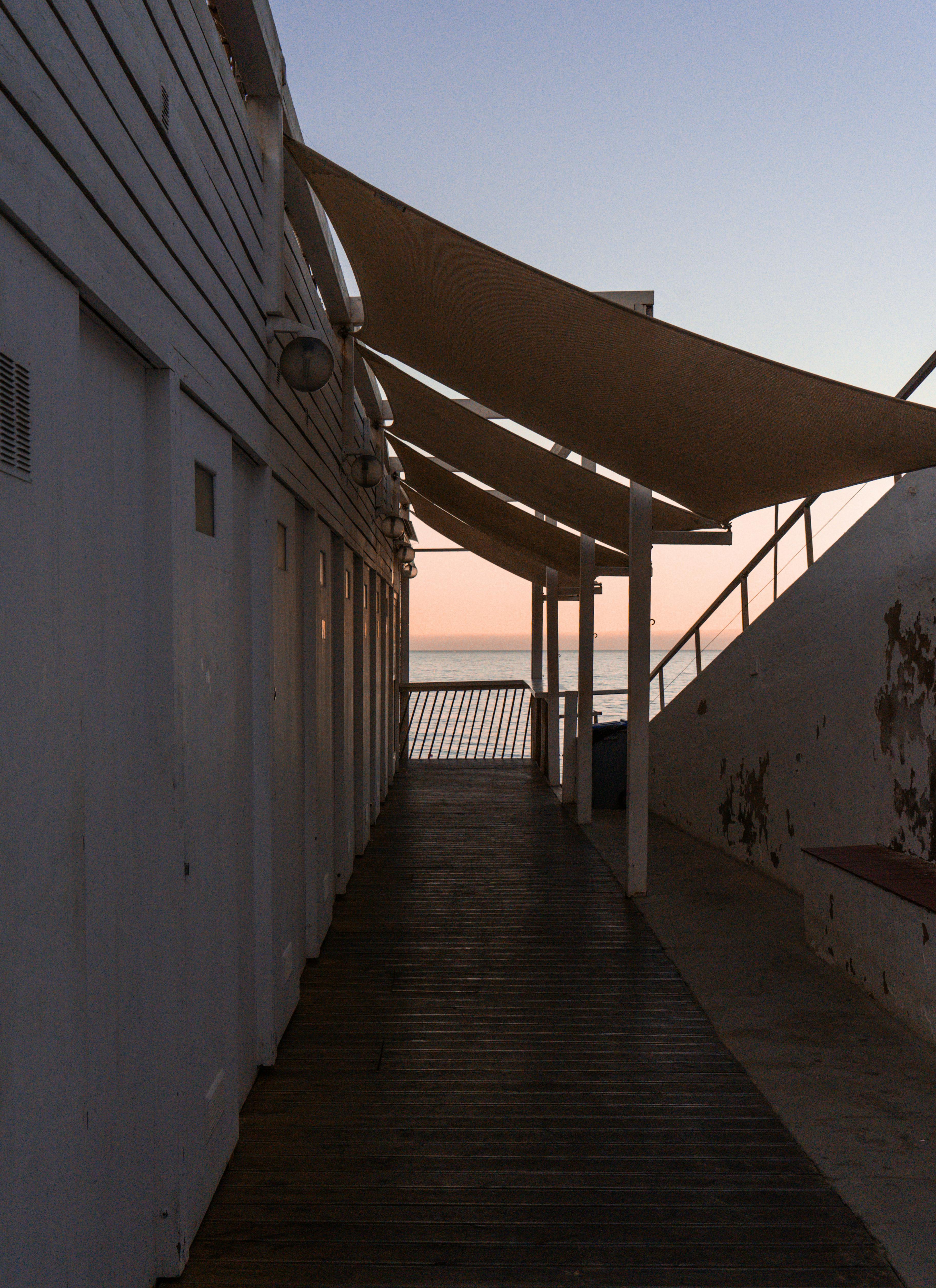 Covers over Pavement near Building · Free Stock Photo