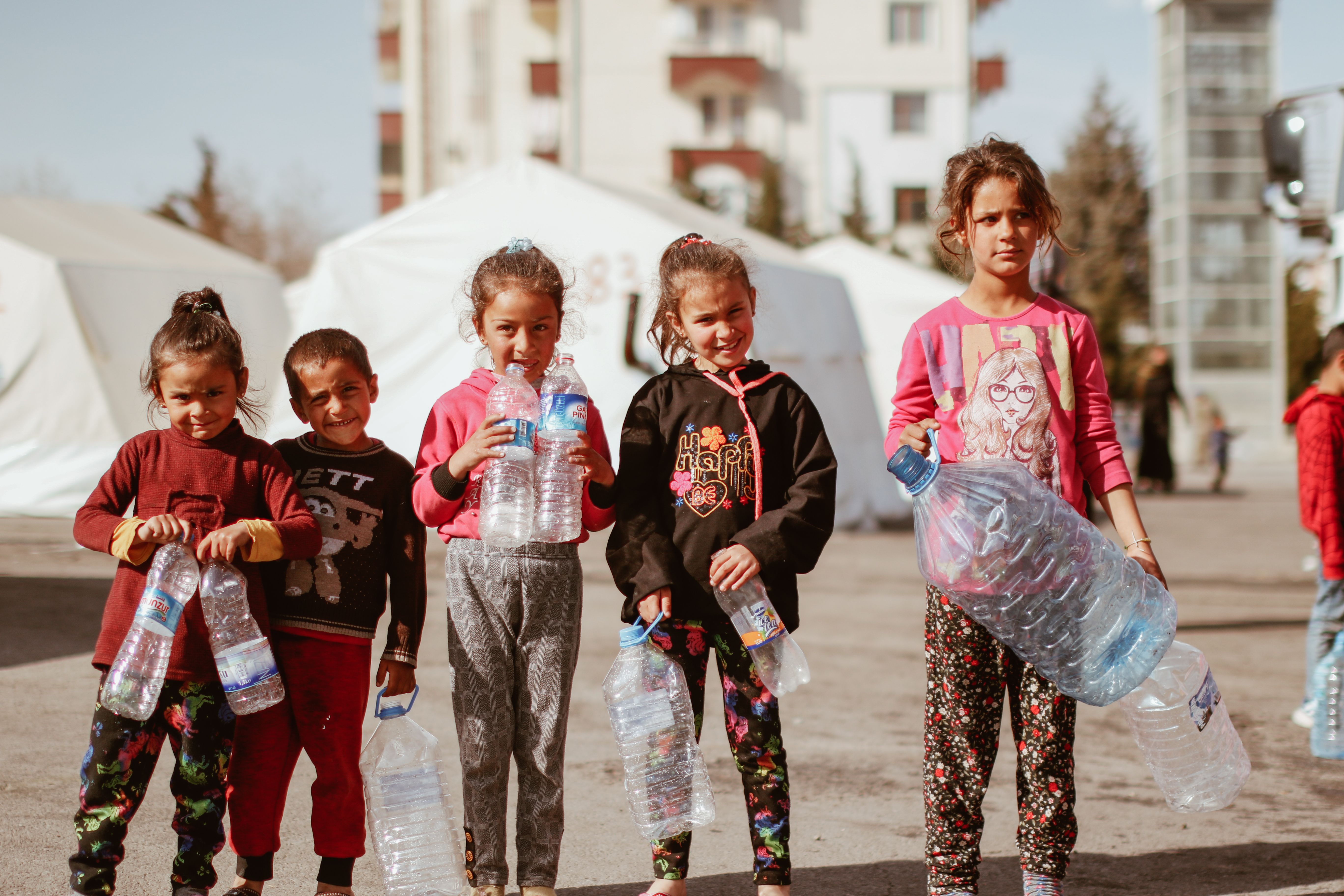 Children with Empty Plastic Bottles · Free Stock Photo
