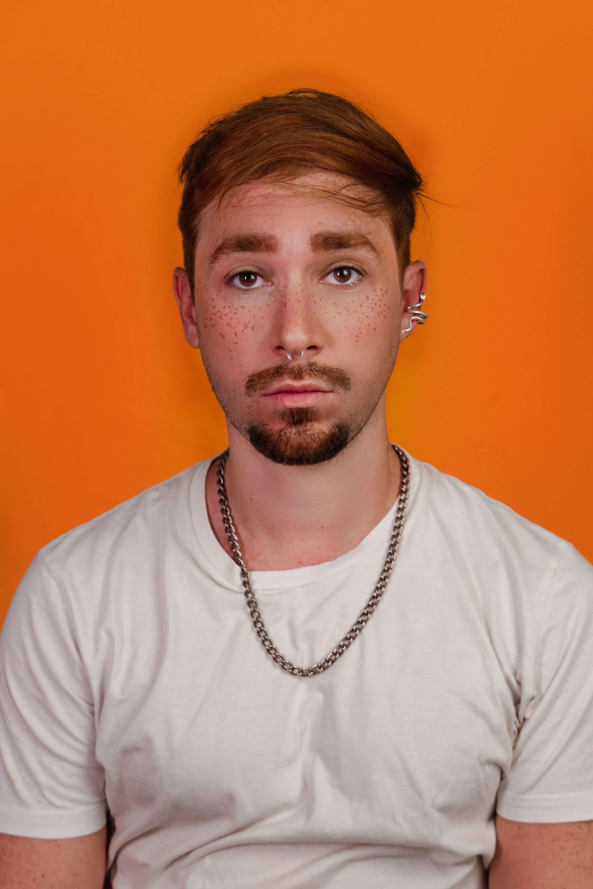 Studio Portrait of a Young Man with Mustache and Stubble, Wearing a ...