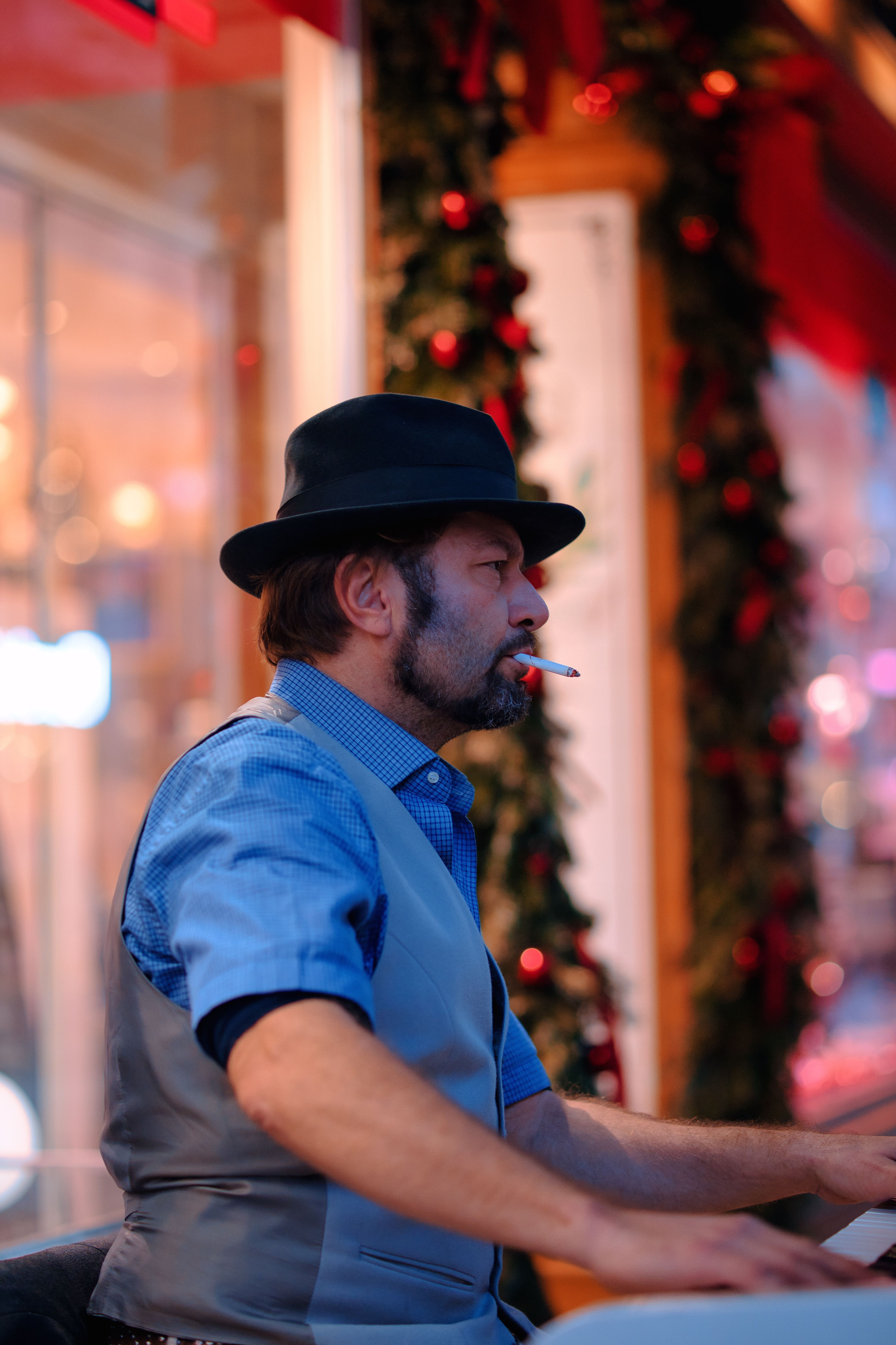 Man Smoking Cigarette while Playing Synthesizer in City · Free Stock Photo