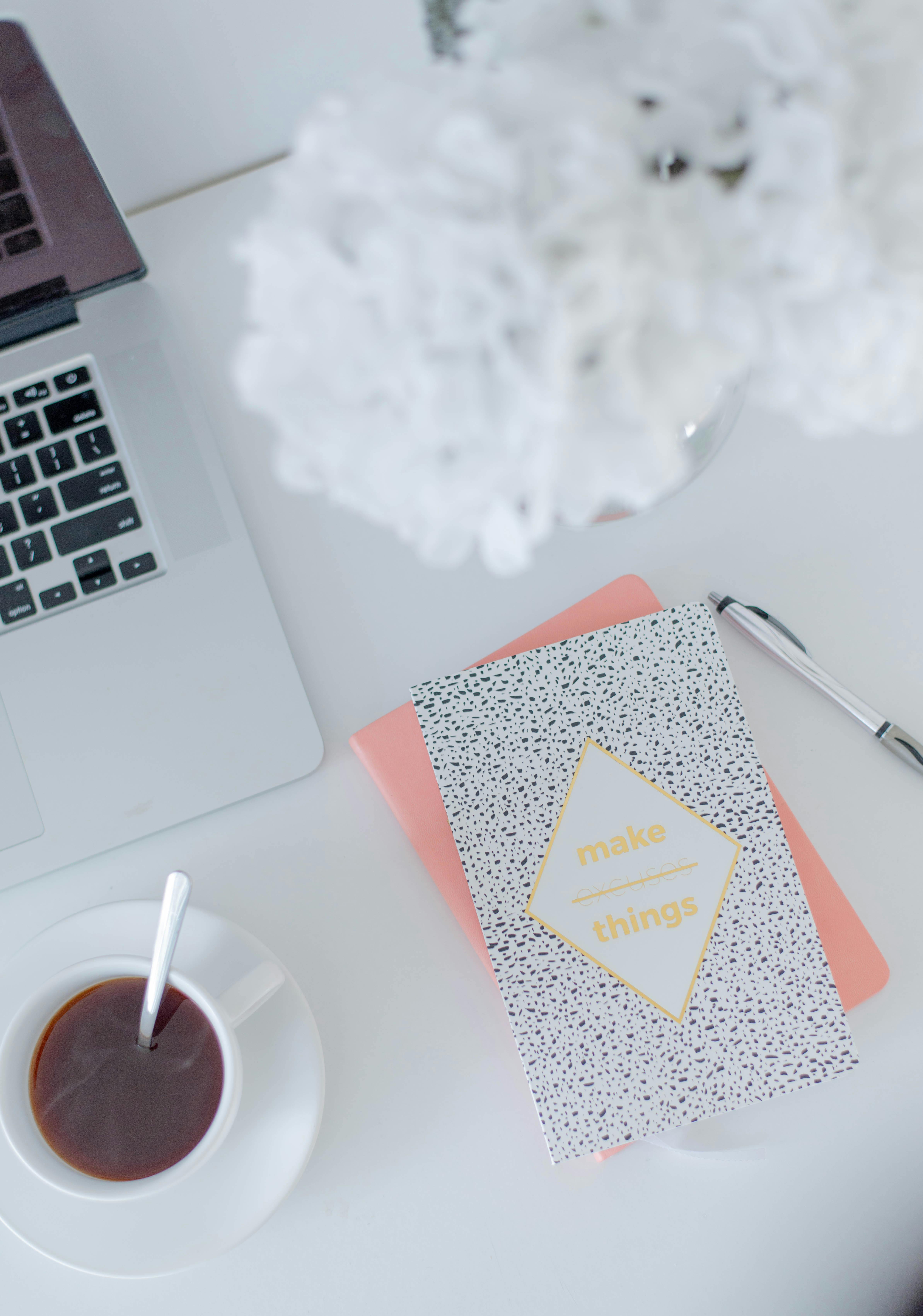 Canon Gray and Black Bridge Camera Near Orange and Blue Spiral Notebook ...