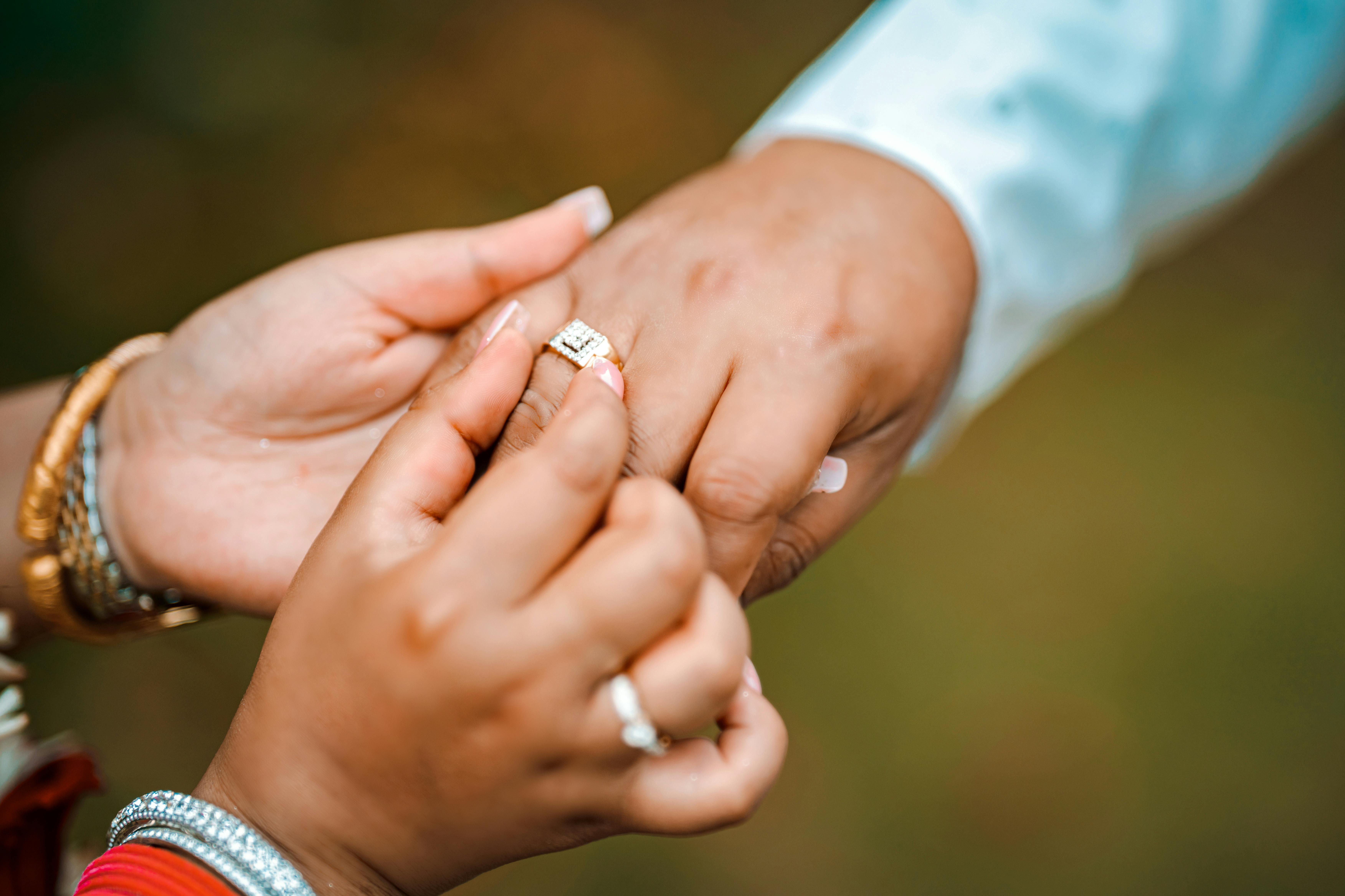 Close-up of Two Hands with Wedding Rings · Free Stock Photo