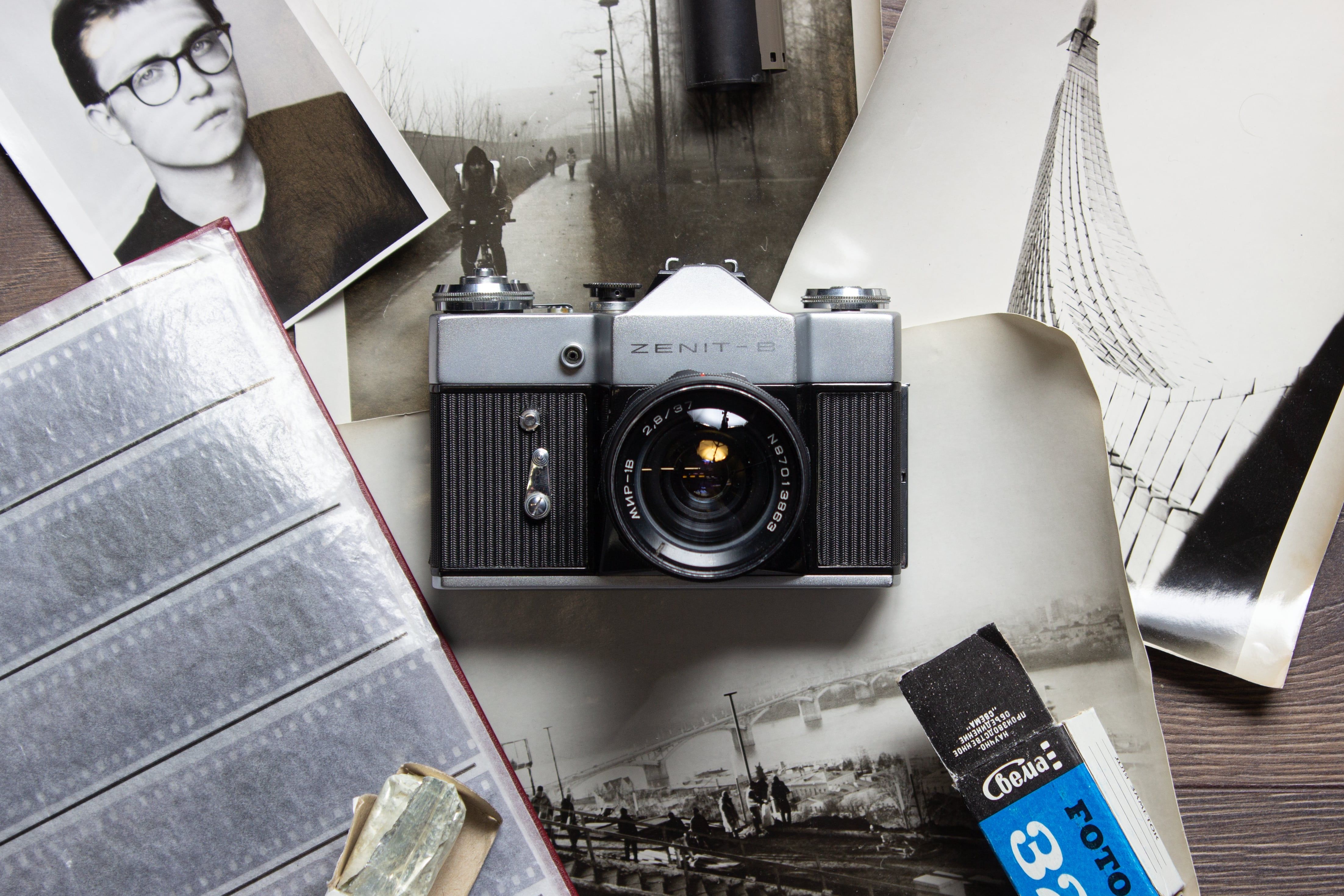 Photos and Retro Camera on Desk · Free Stock Photo