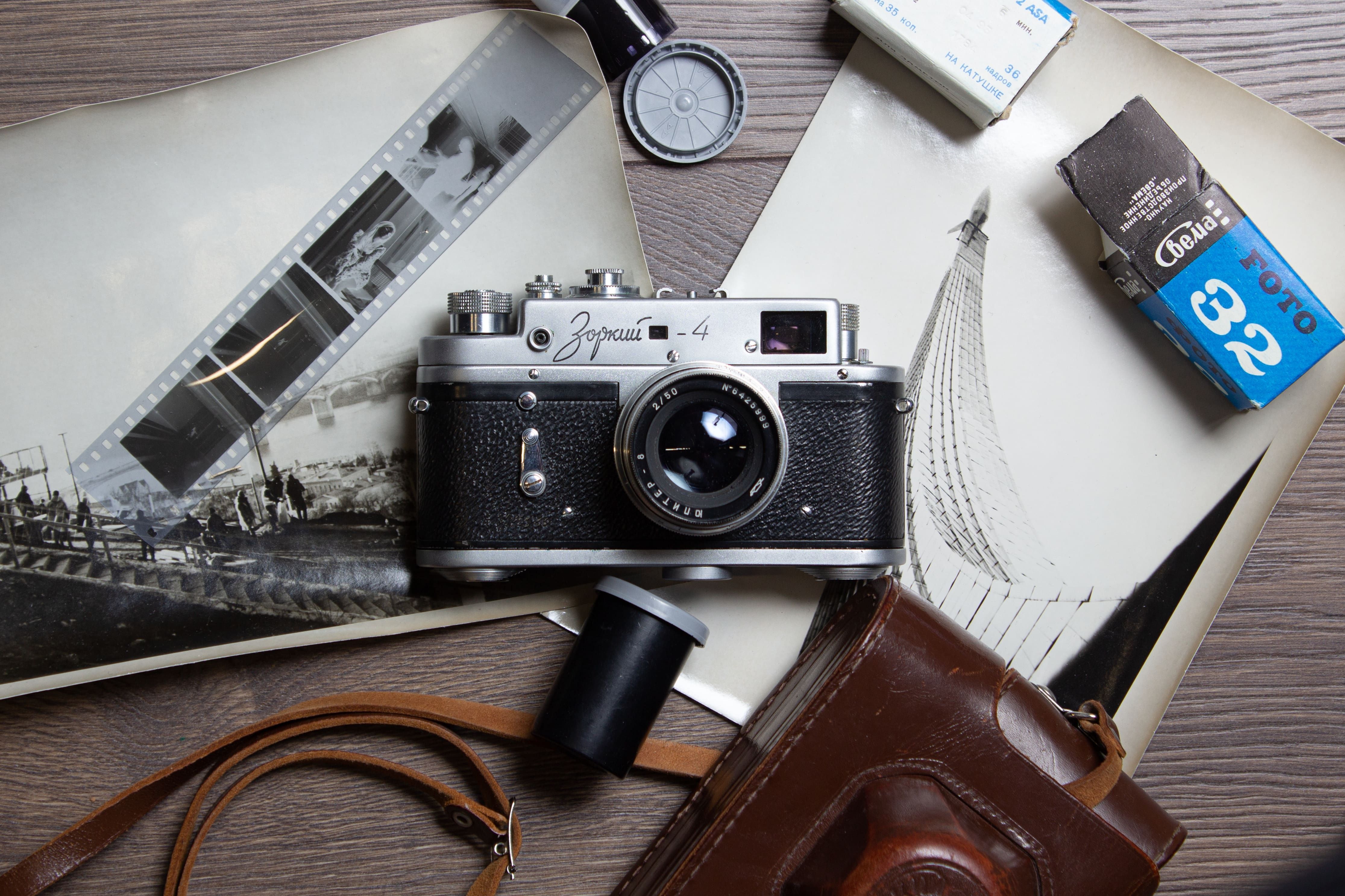 Camera Zorki 4 with Leather Case and Rolls of 35mm Film · Free Stock Photo