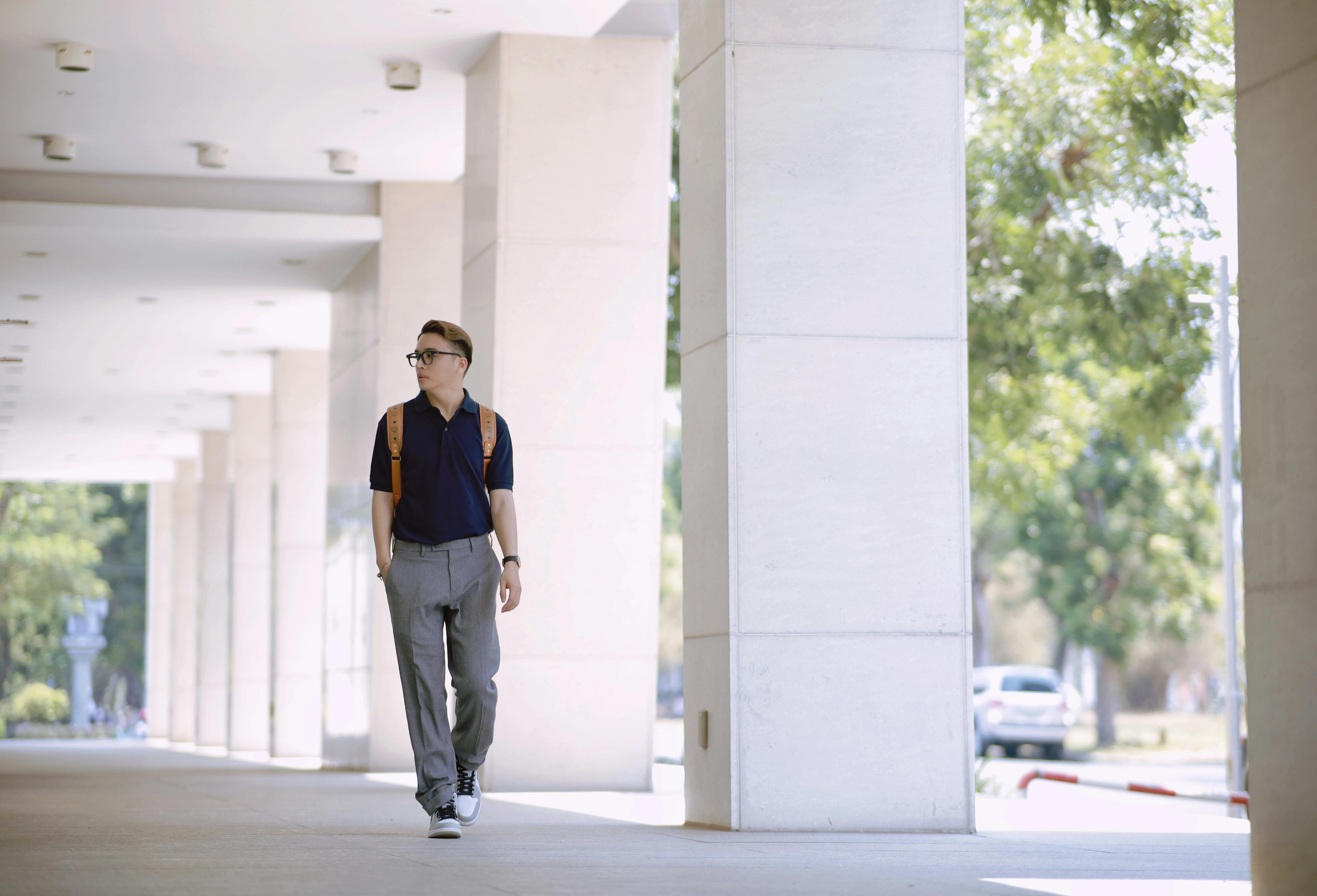 Man Wearing Backpack on City Street · Free Stock Photo