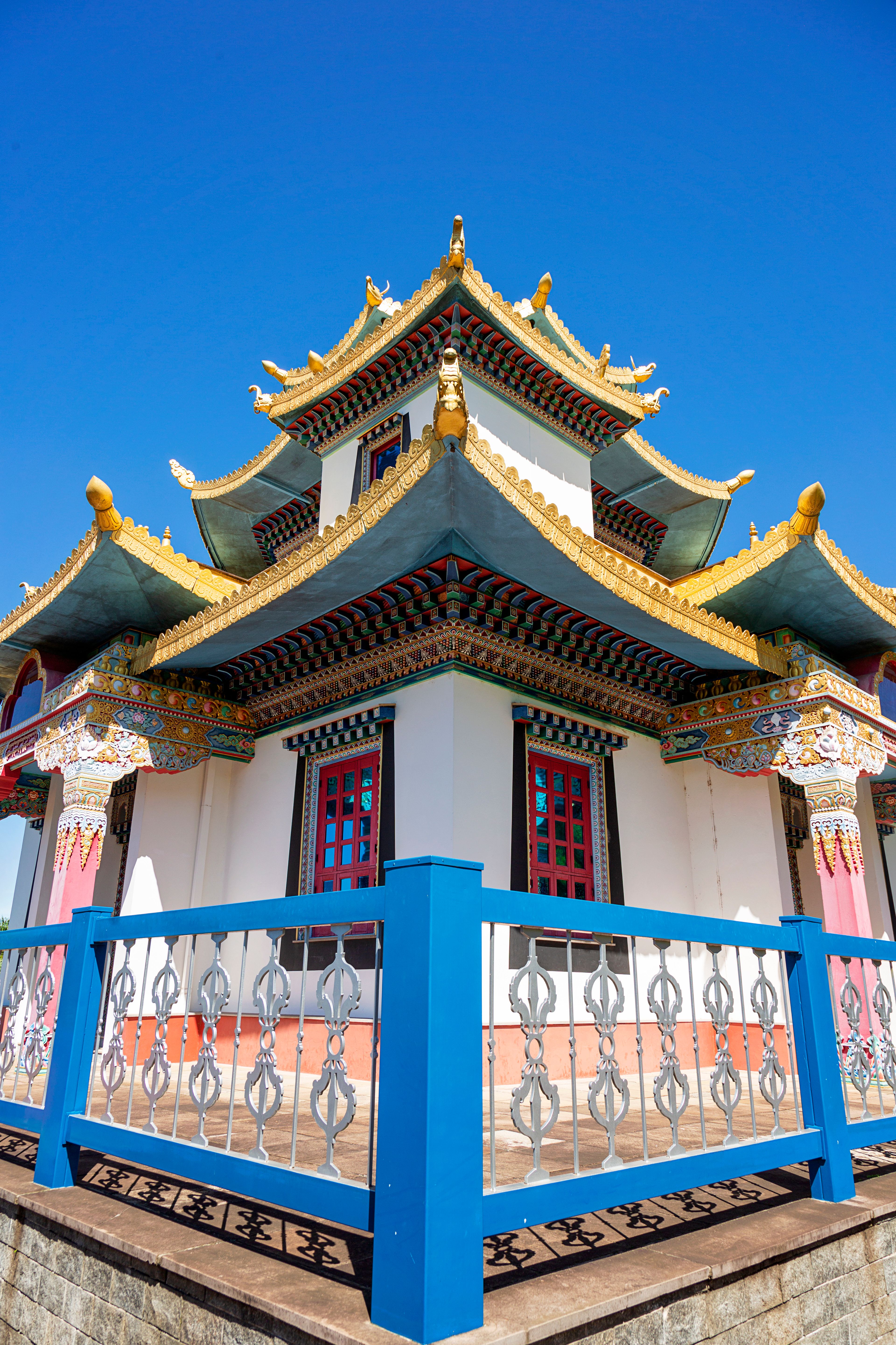 Blue Fence and Pagoda with Golden Decorations · Free Stock Photo