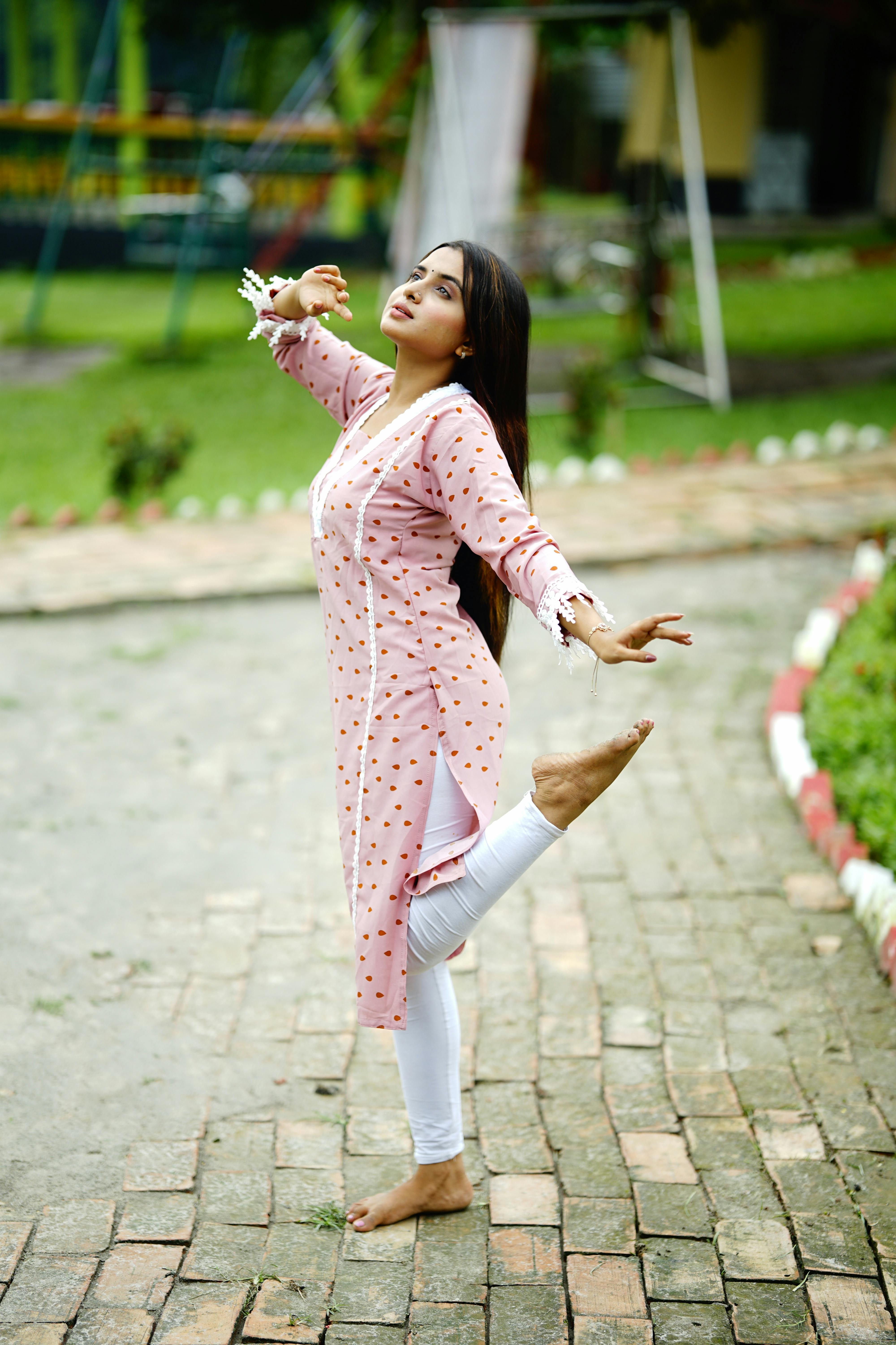 Young Woman Standing Barefoot in a Park · Free Stock Photo