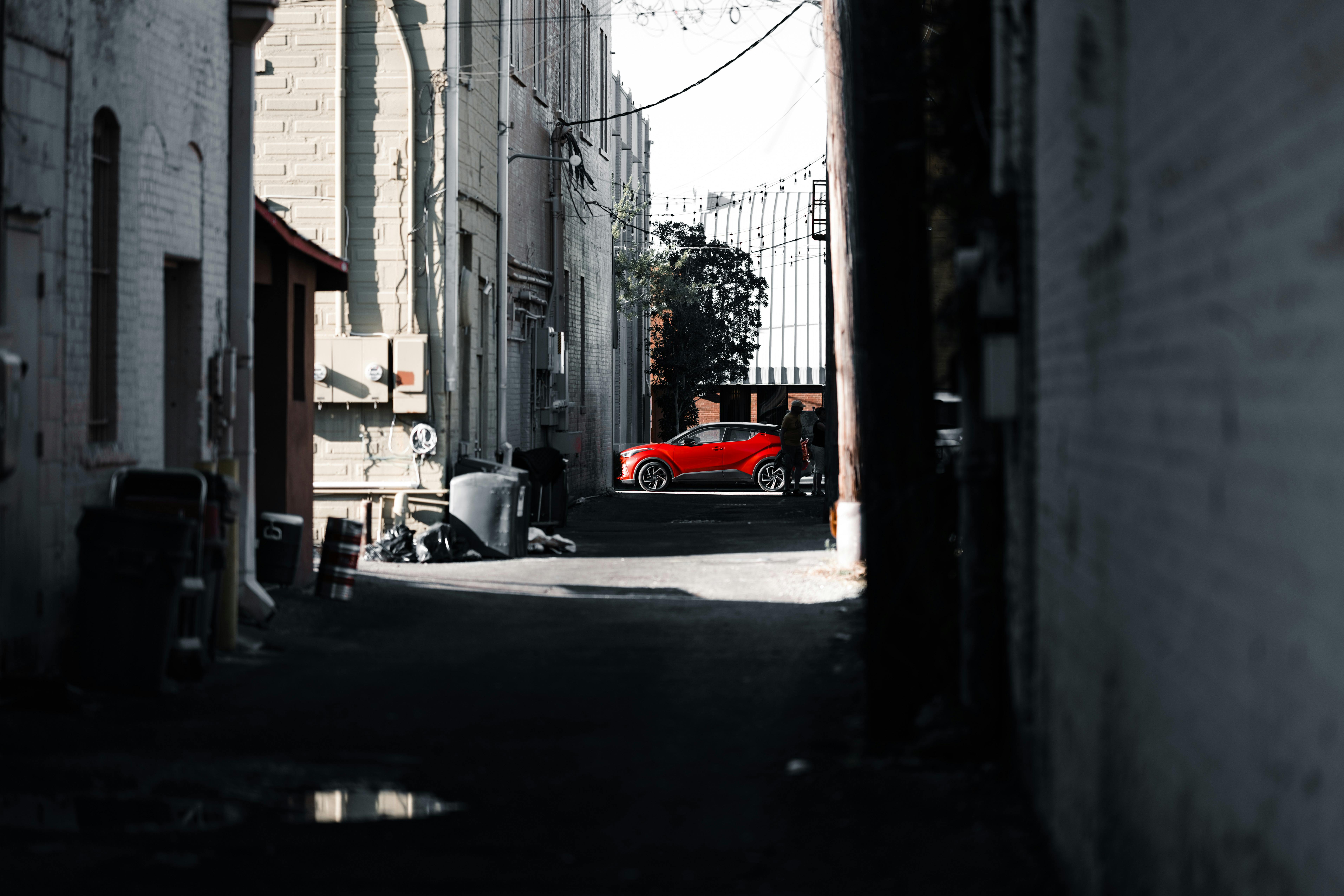 A Red Car Parked at the End of an Alleyway · Free Stock Photo