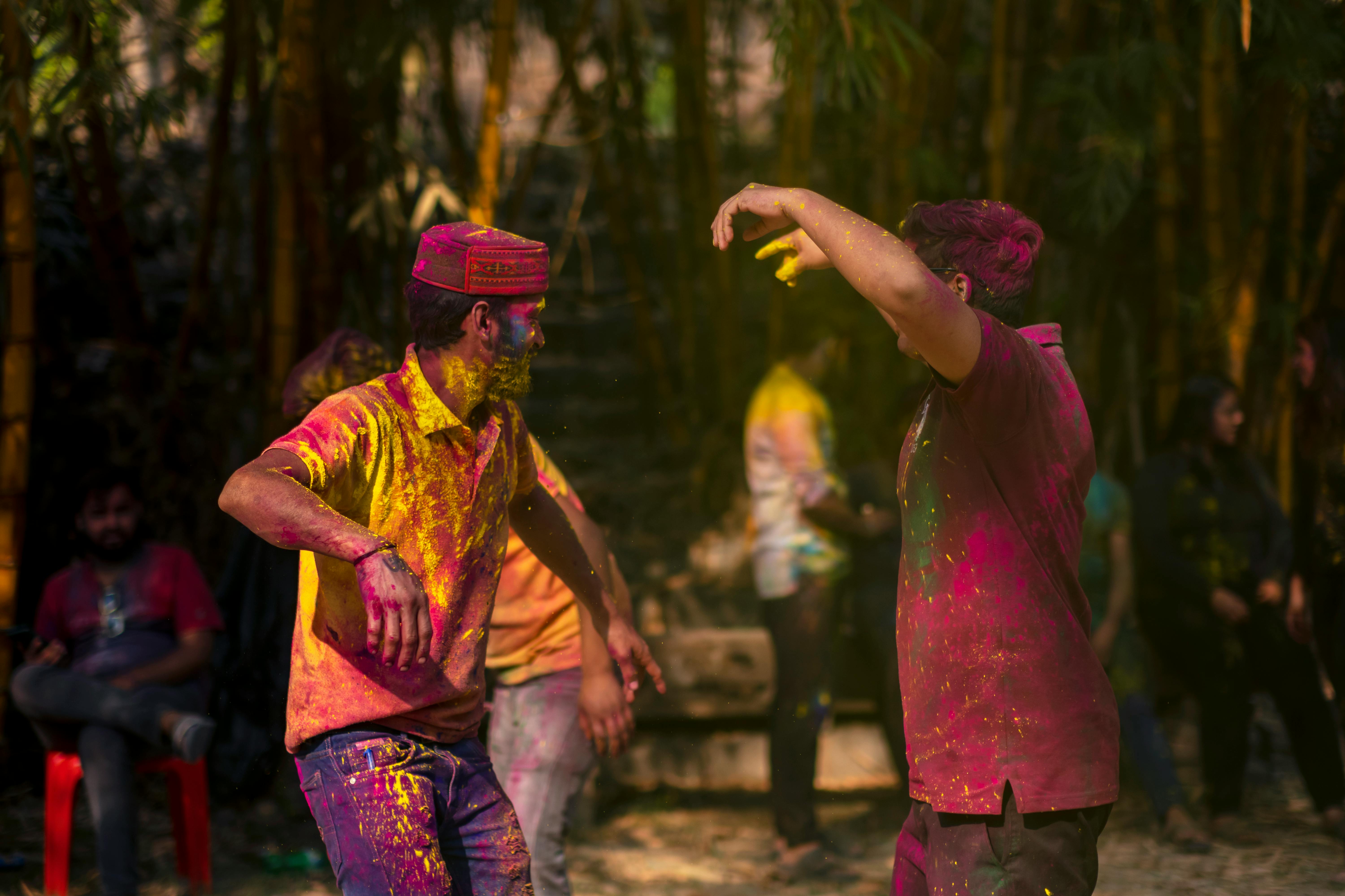 Men Covered in Colorful Powder Dancing · Free Stock Photo