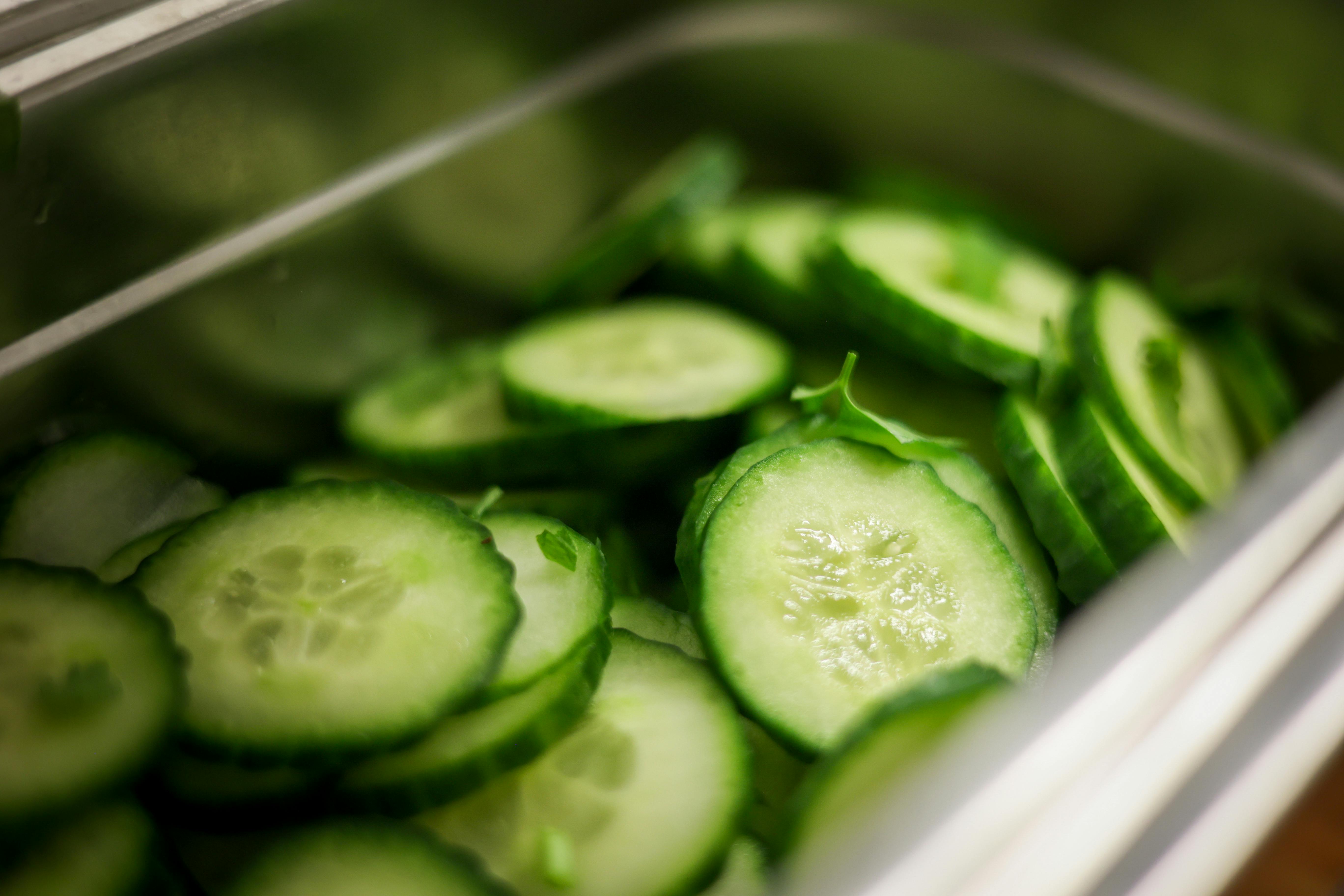 Close-up of Sliced Cucumbers in a Steel Container · Free Stock Photo