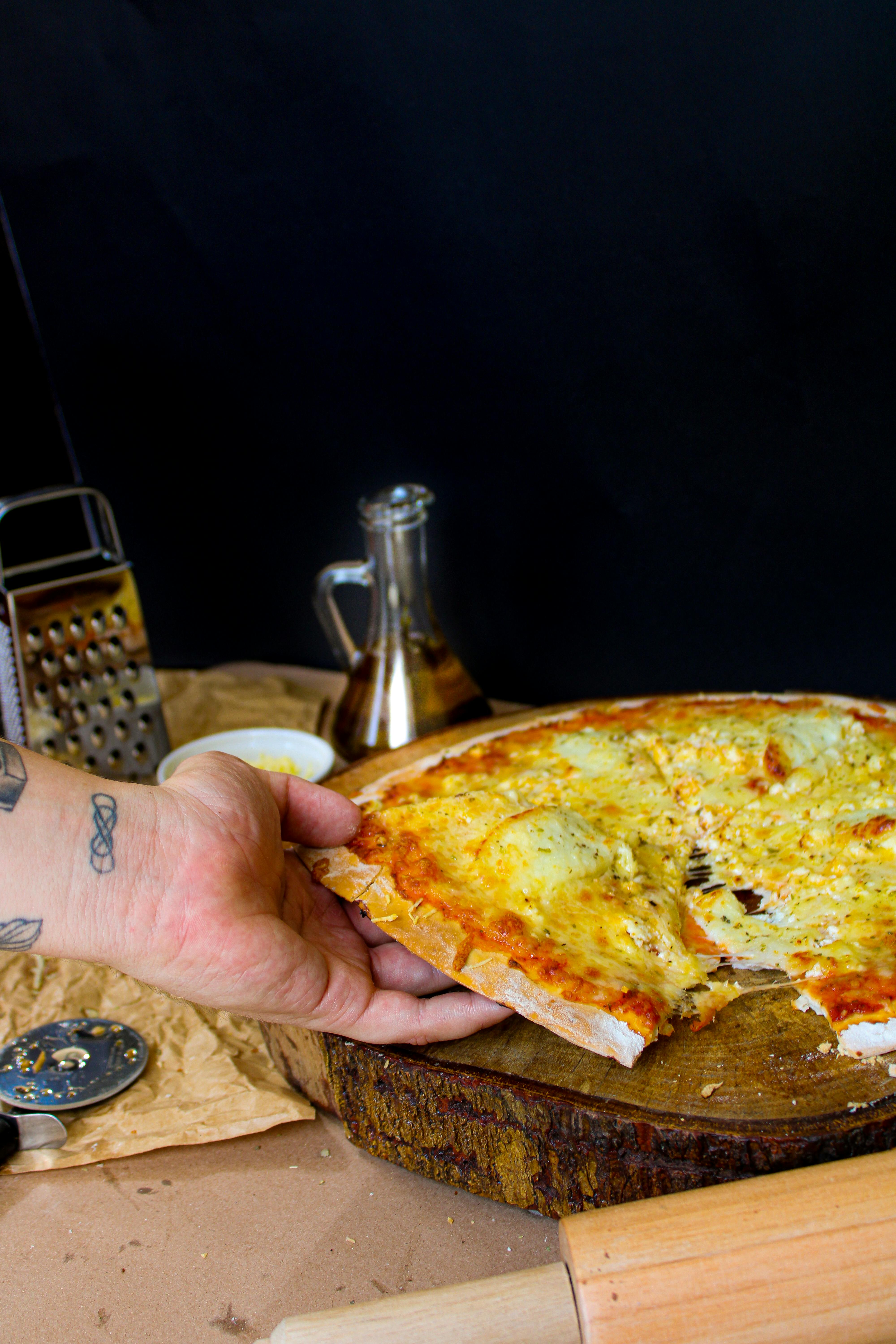 Hand Holding Pizza · Free Stock Photo