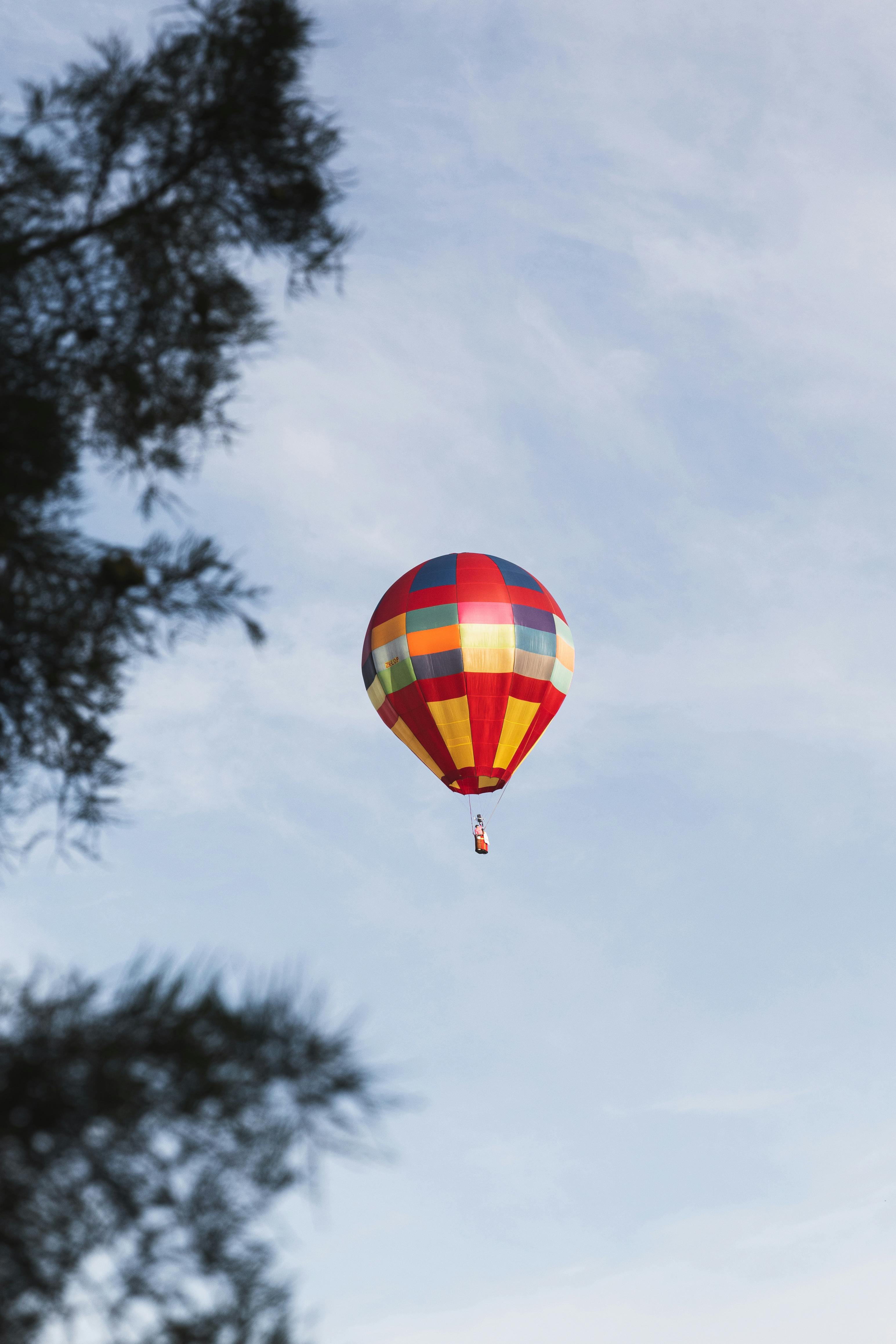 A Hot Air Balloon Flying against Blue Sky · Free Stock Photo