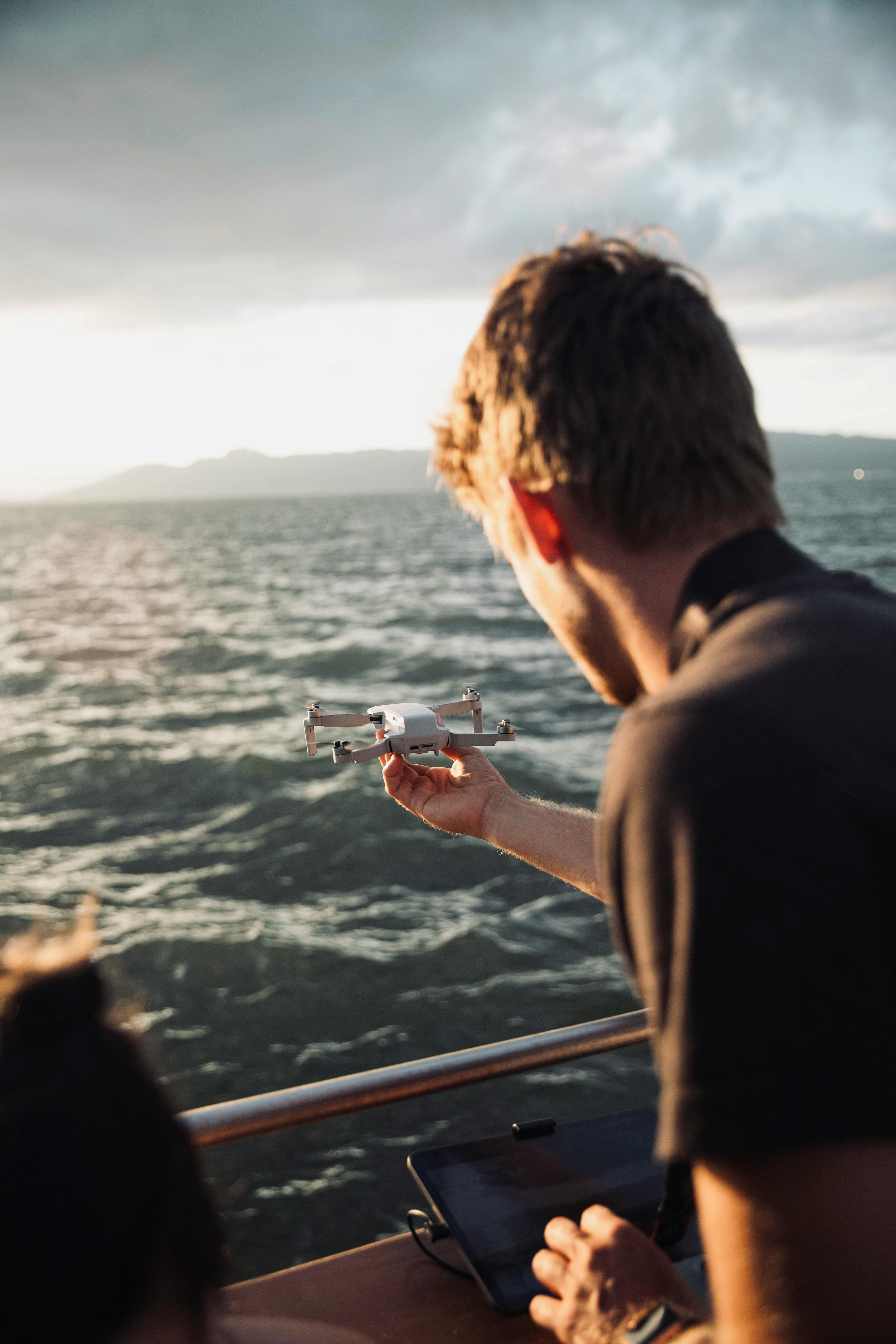 Man Holding Drone over Water · Free Stock Photo