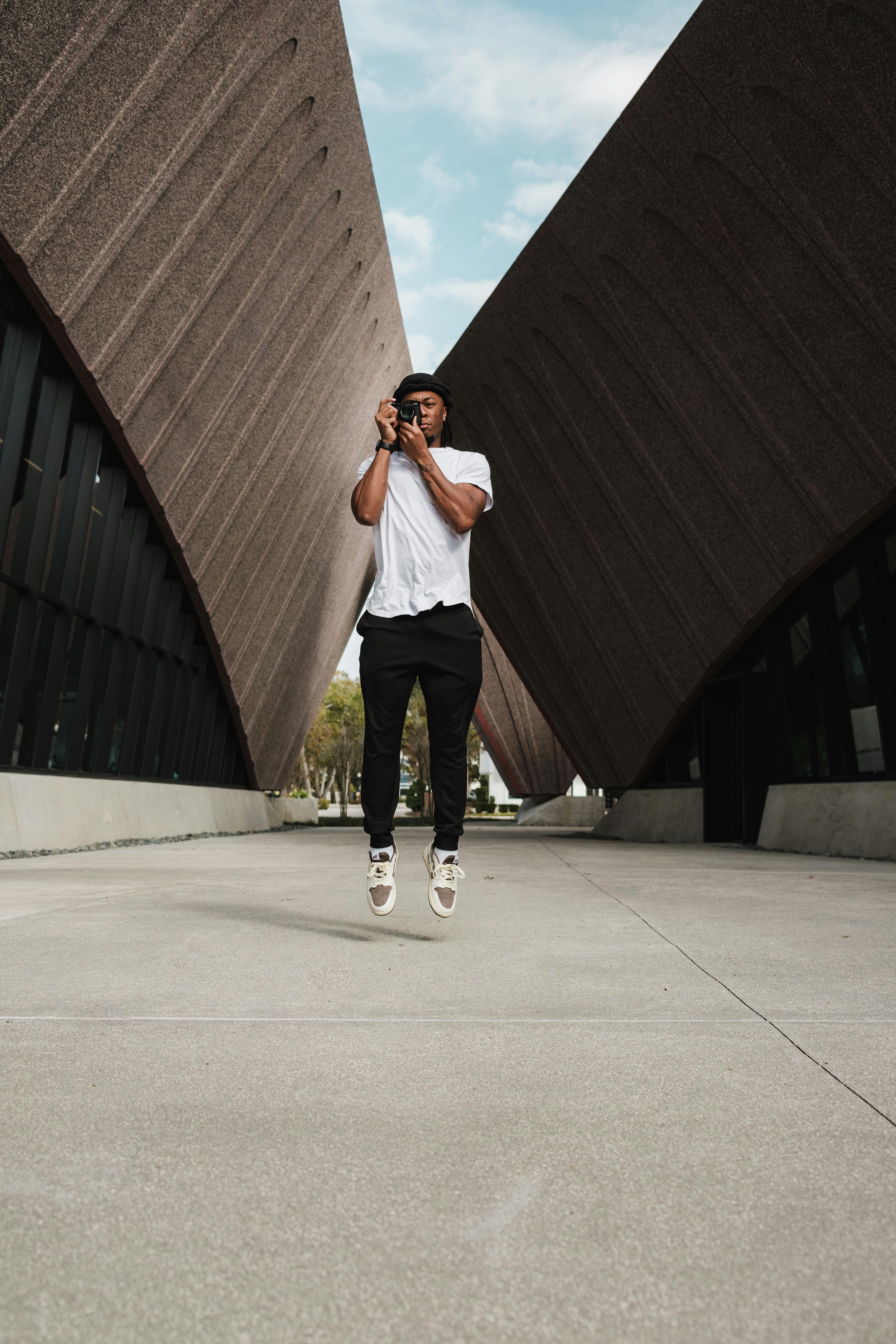 Man with Camera Jumping · Free Stock Photo
