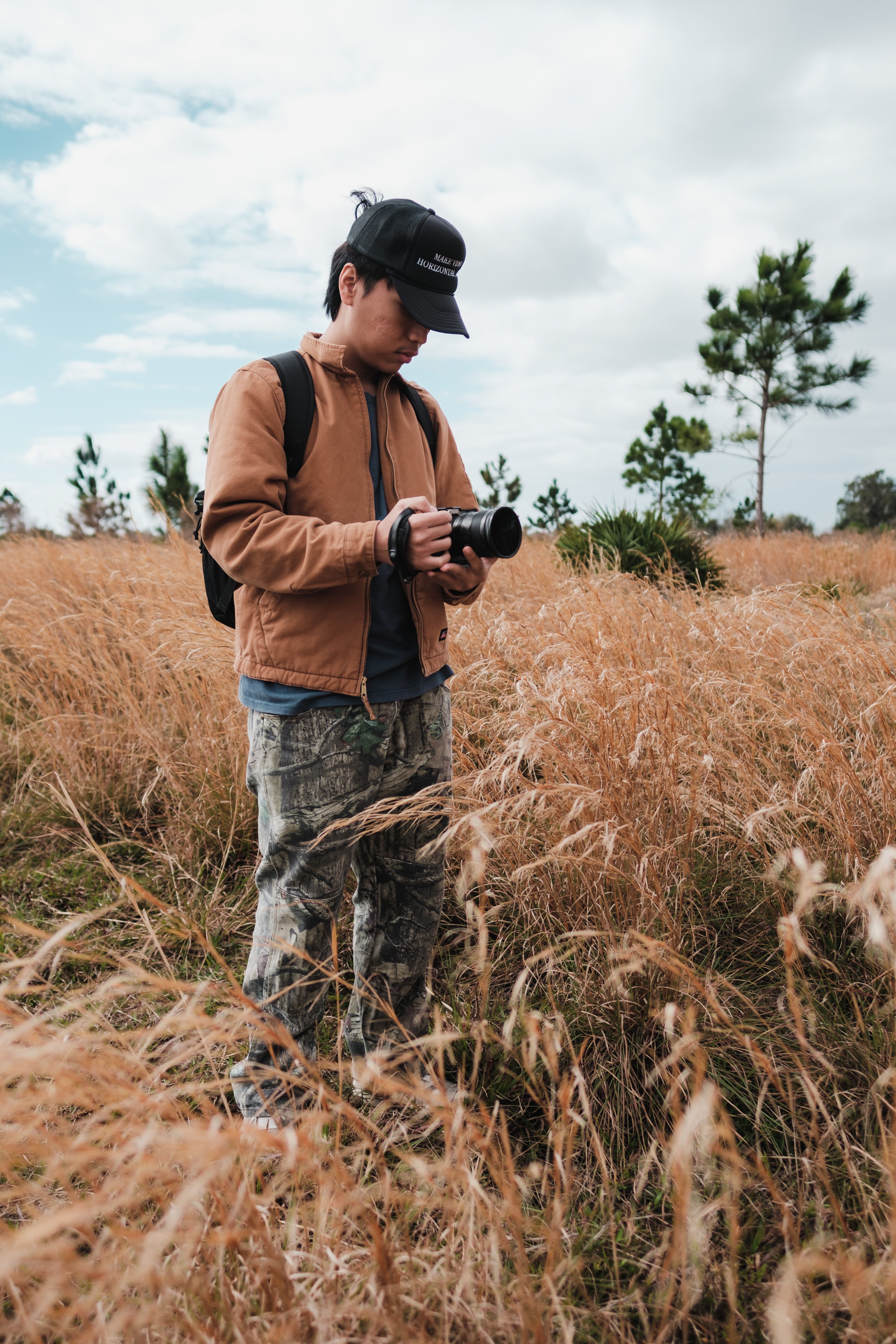 Man with Camera on Field · Free Stock Photo