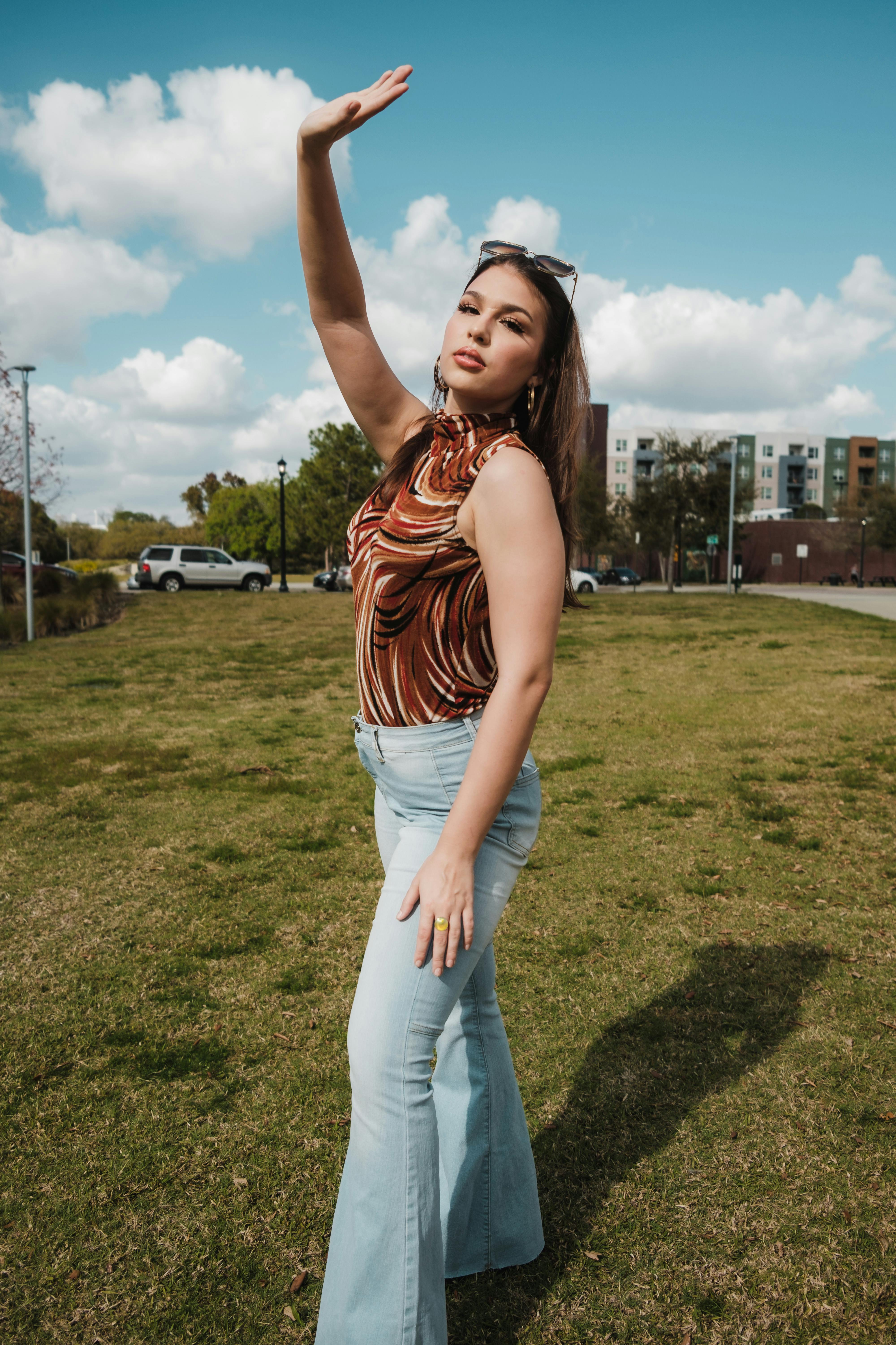 Woman Posing with Arm Raised · Free Stock Photo