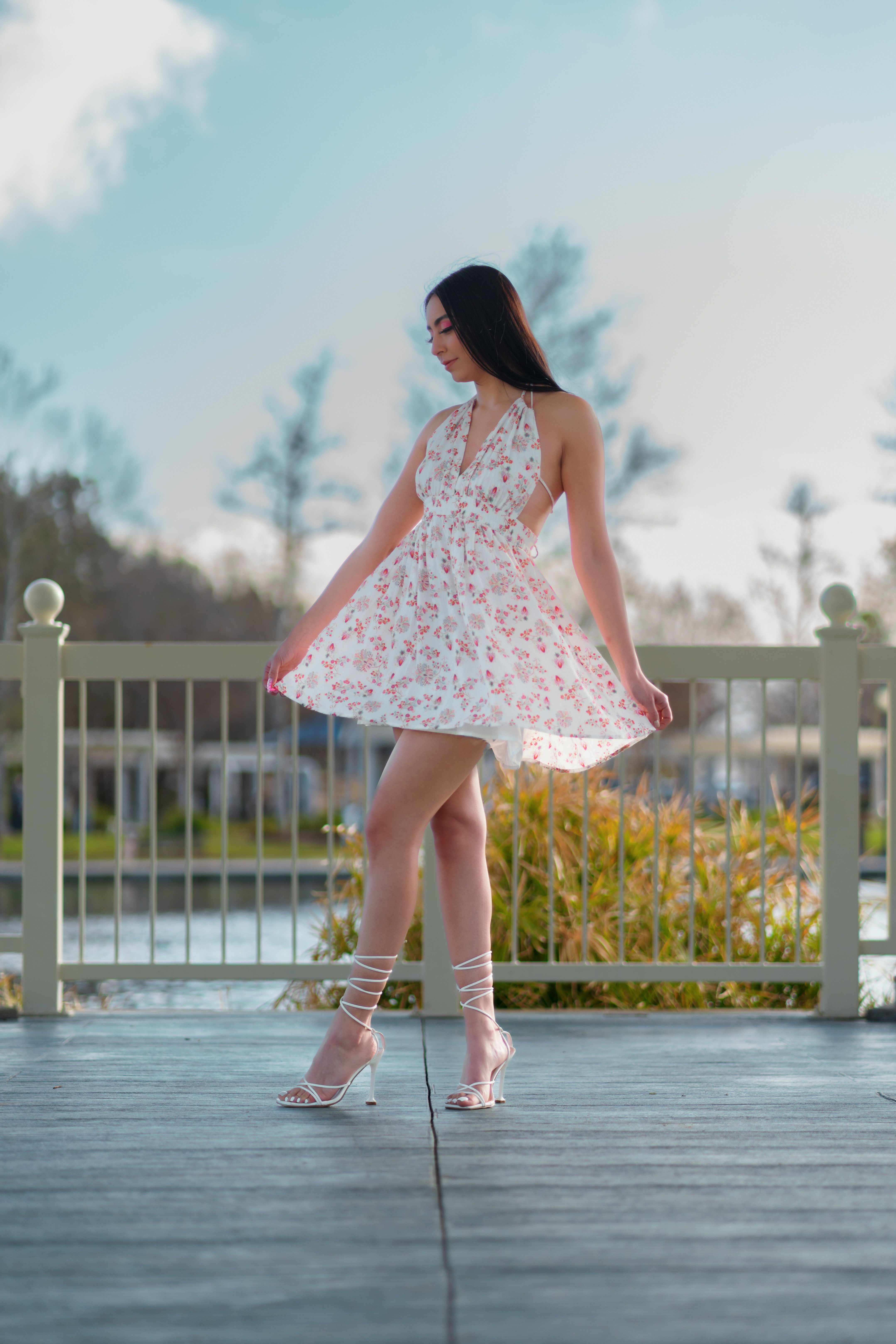 Woman Sitting and Posing by Railing · Free Stock Photo