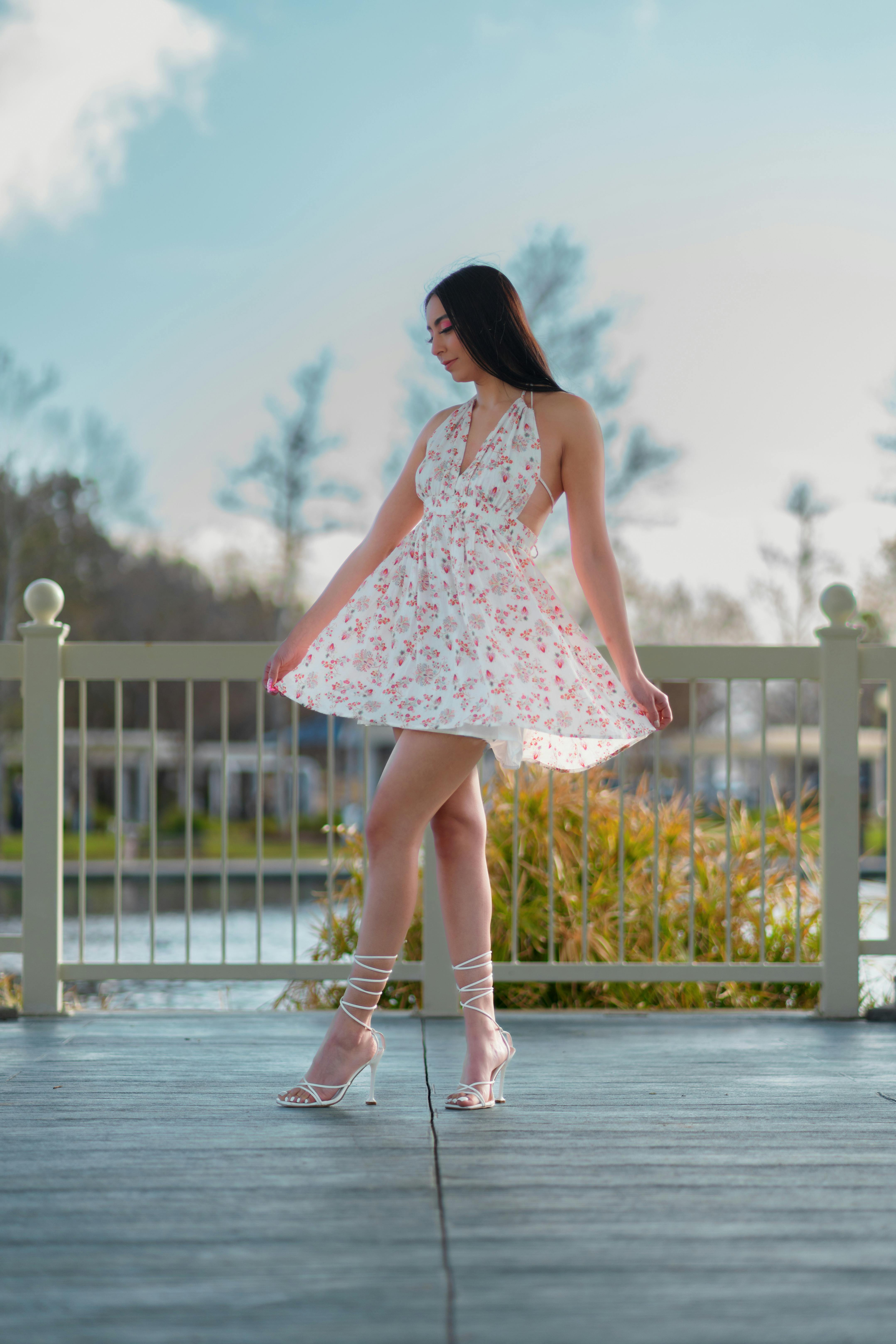Woman Sitting and Posing by Railing · Free Stock Photo