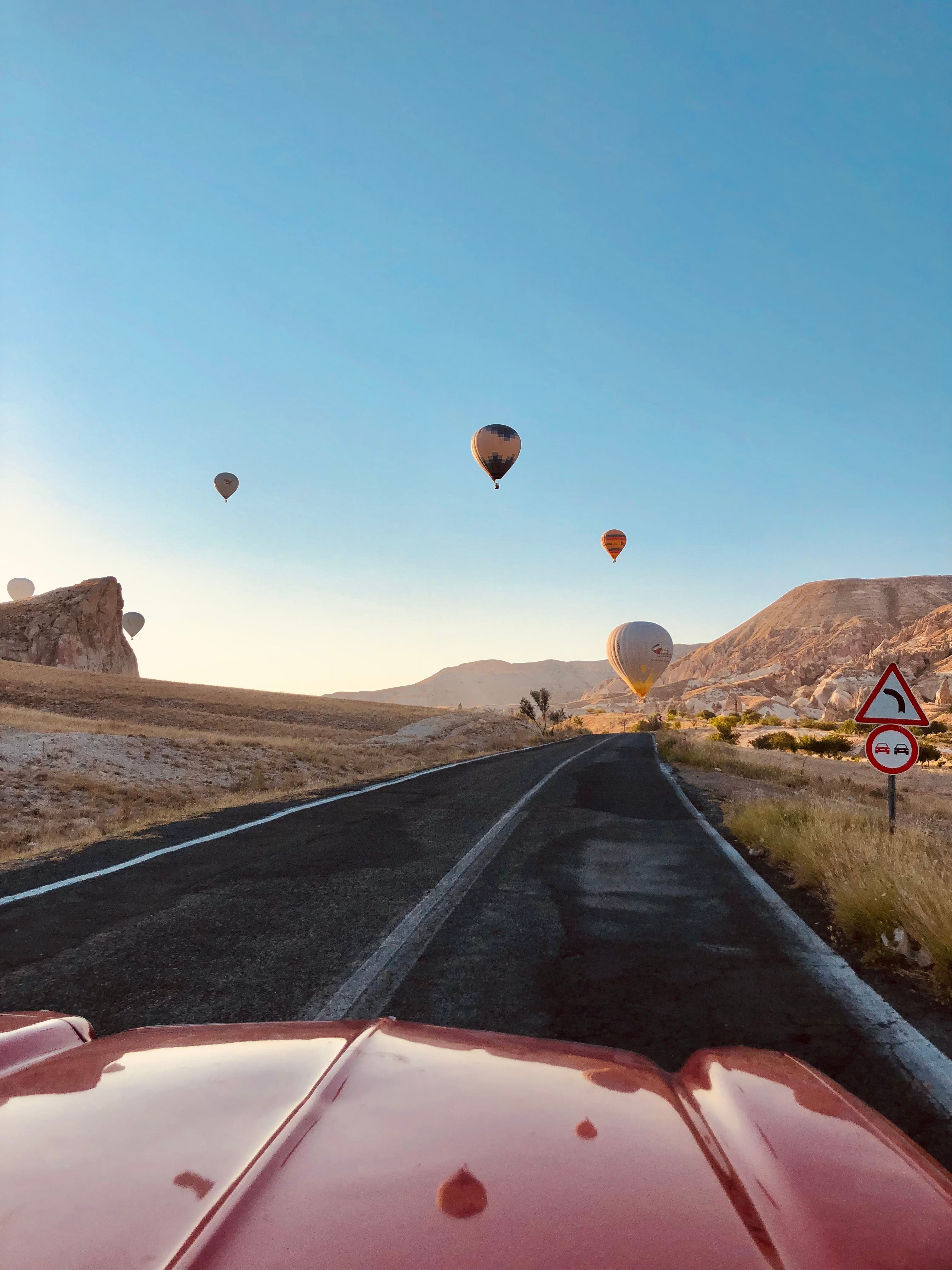 View of a Road and Hot Air Balloons from a Car · Free Stock Photo