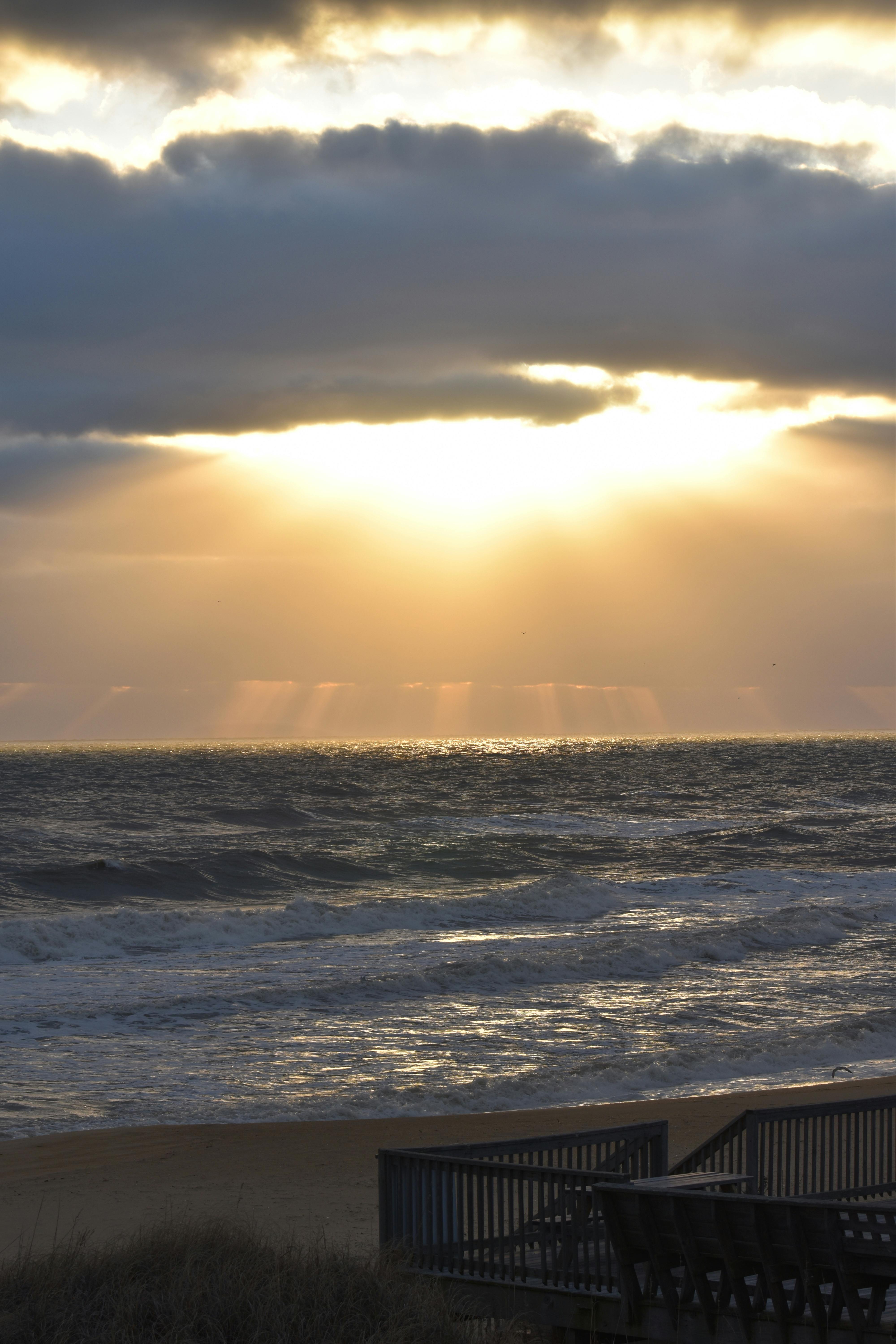 Sunlight over Clouds over Beach at Sunset · Free Stock Photo