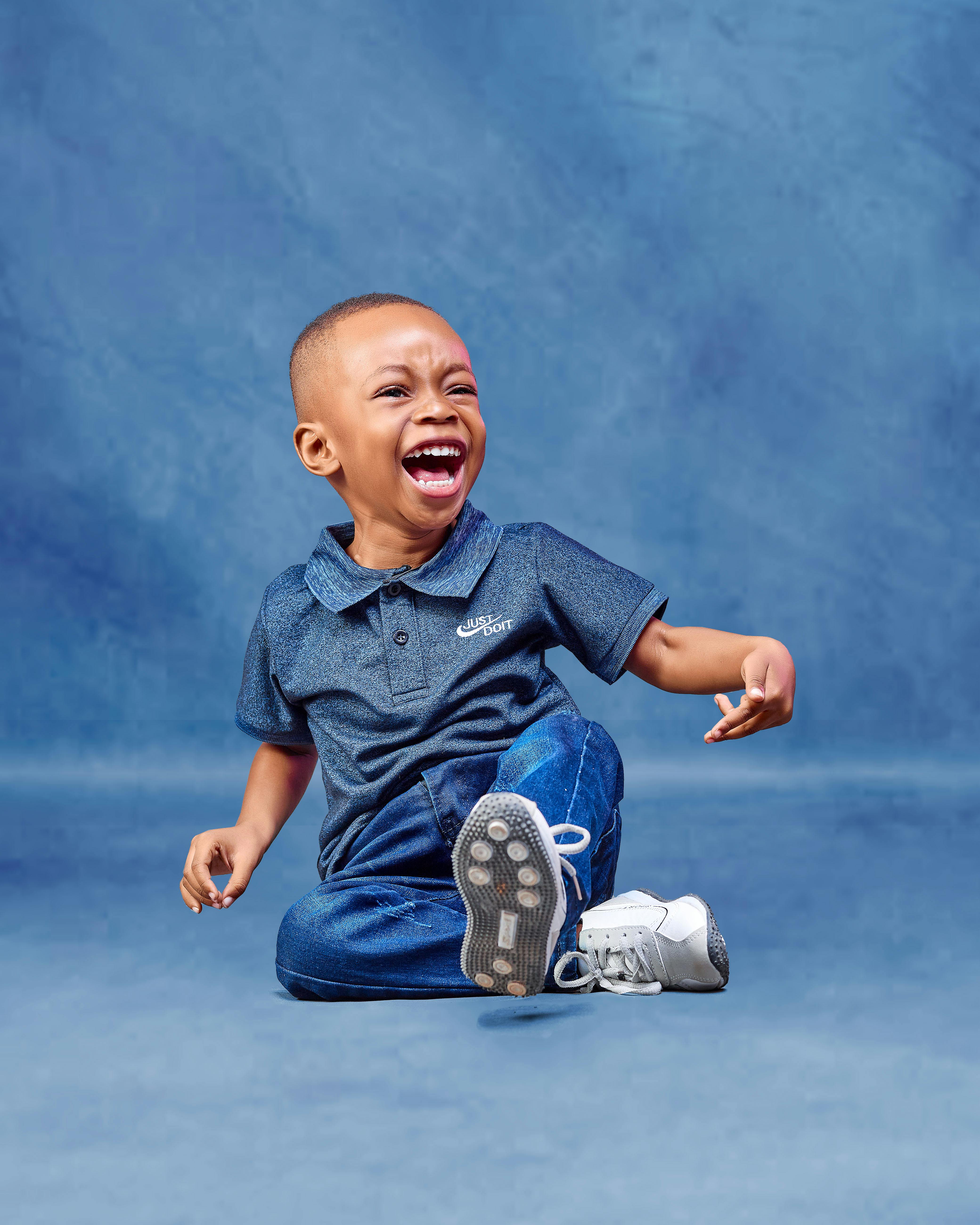 Laughing Boy on Blue Background · Free Stock Photo