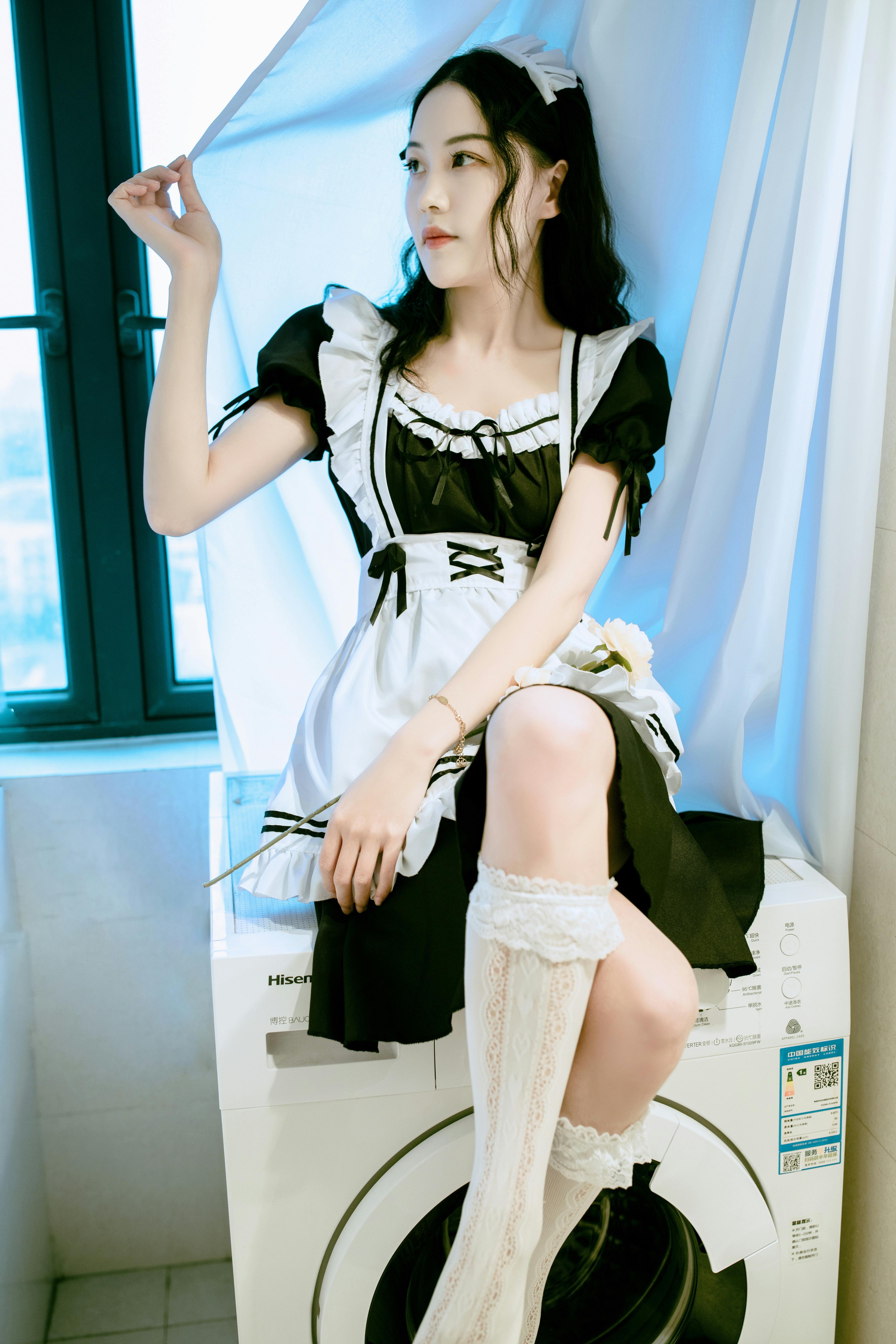 Young Woman in a Maids Costume Sitting on a Washing Machine · Free ...