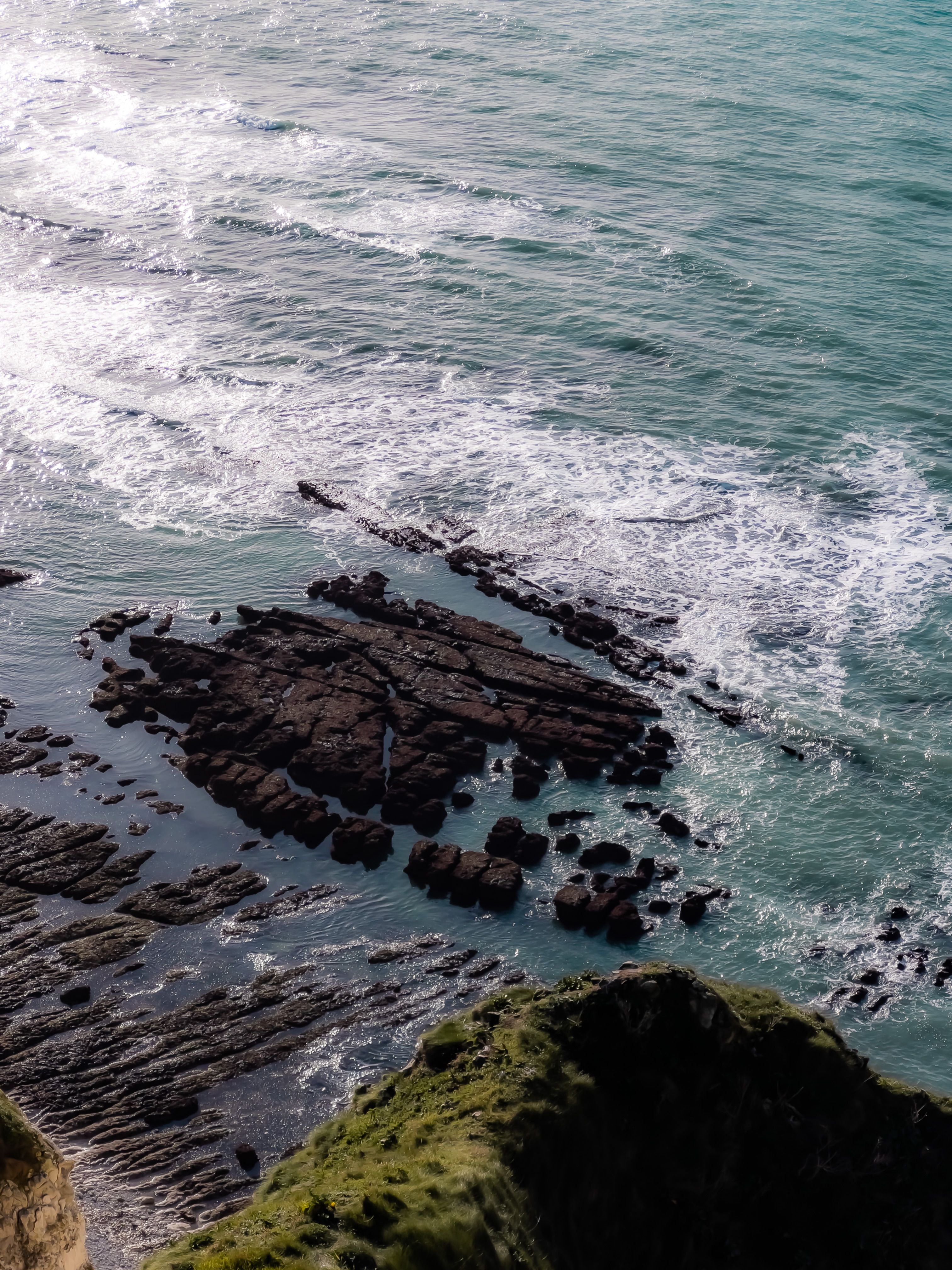Beautiful Ocean with Rocks Under the Blue Sky · Free Stock Photo