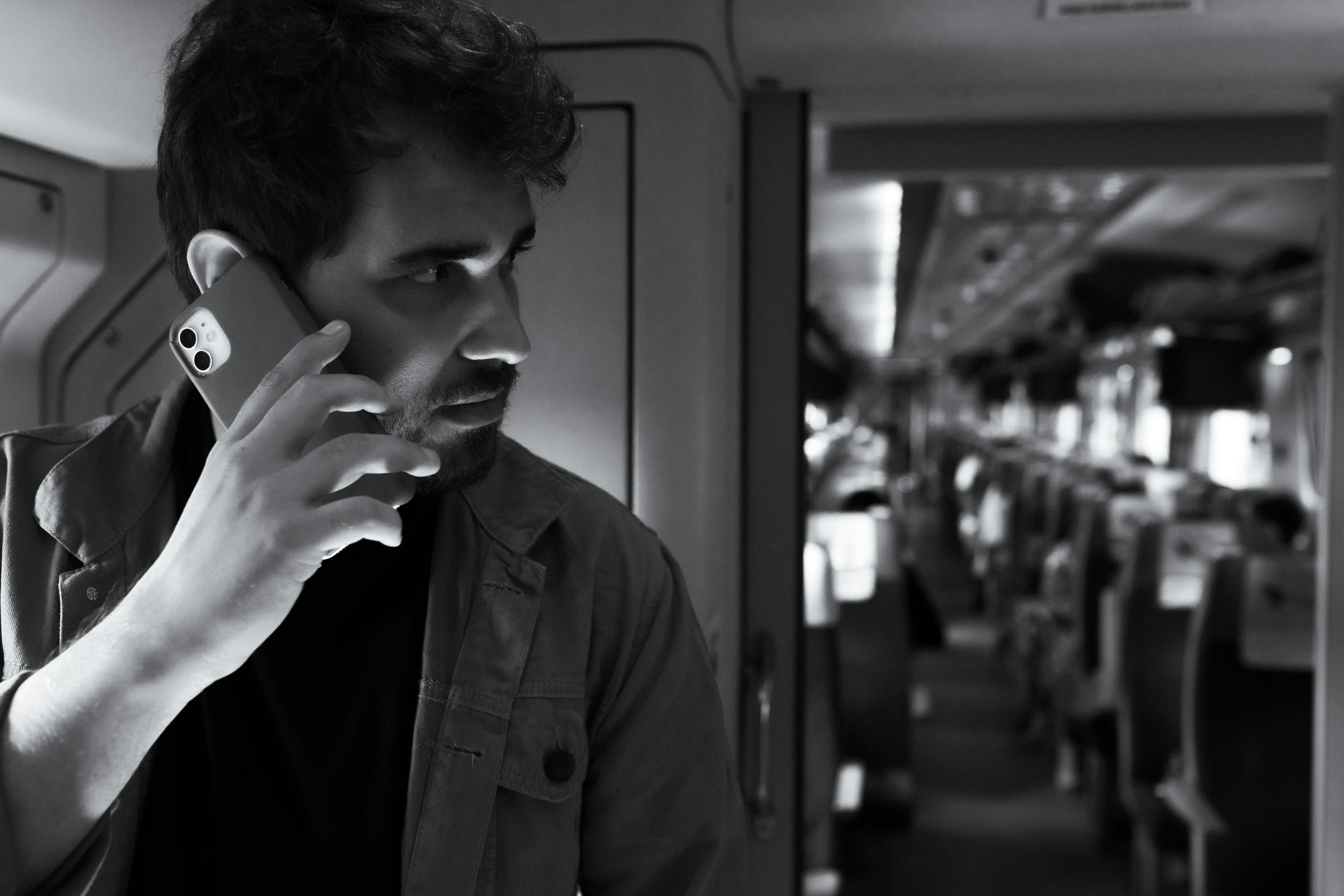 Man in a Train Carriage Talking on the Phone · Free Stock Photo