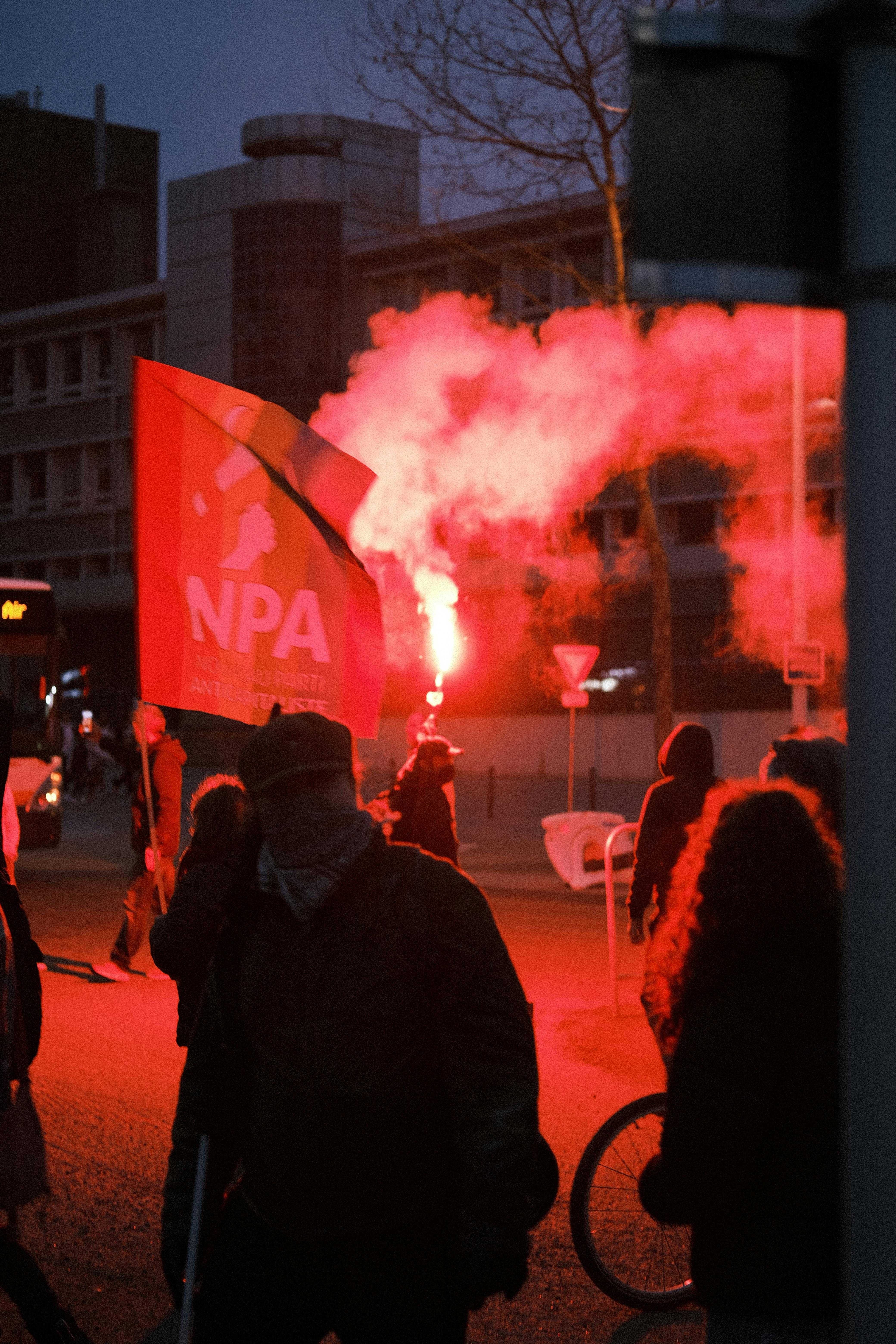 People Lighting up Red Flares at Protest · Free Stock Photo