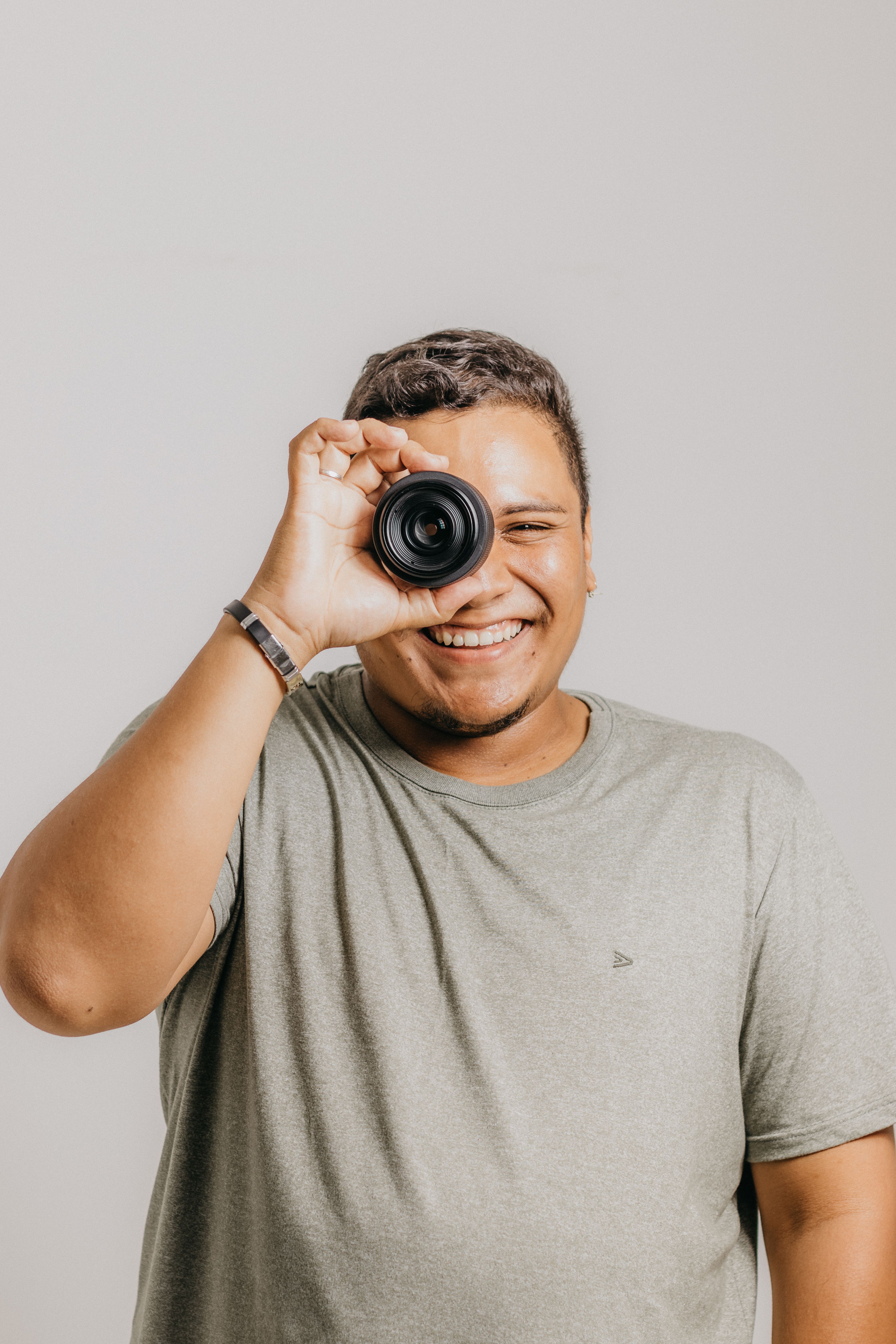 Portrait of Smiling Man with Camera Lens · Free Stock Photo