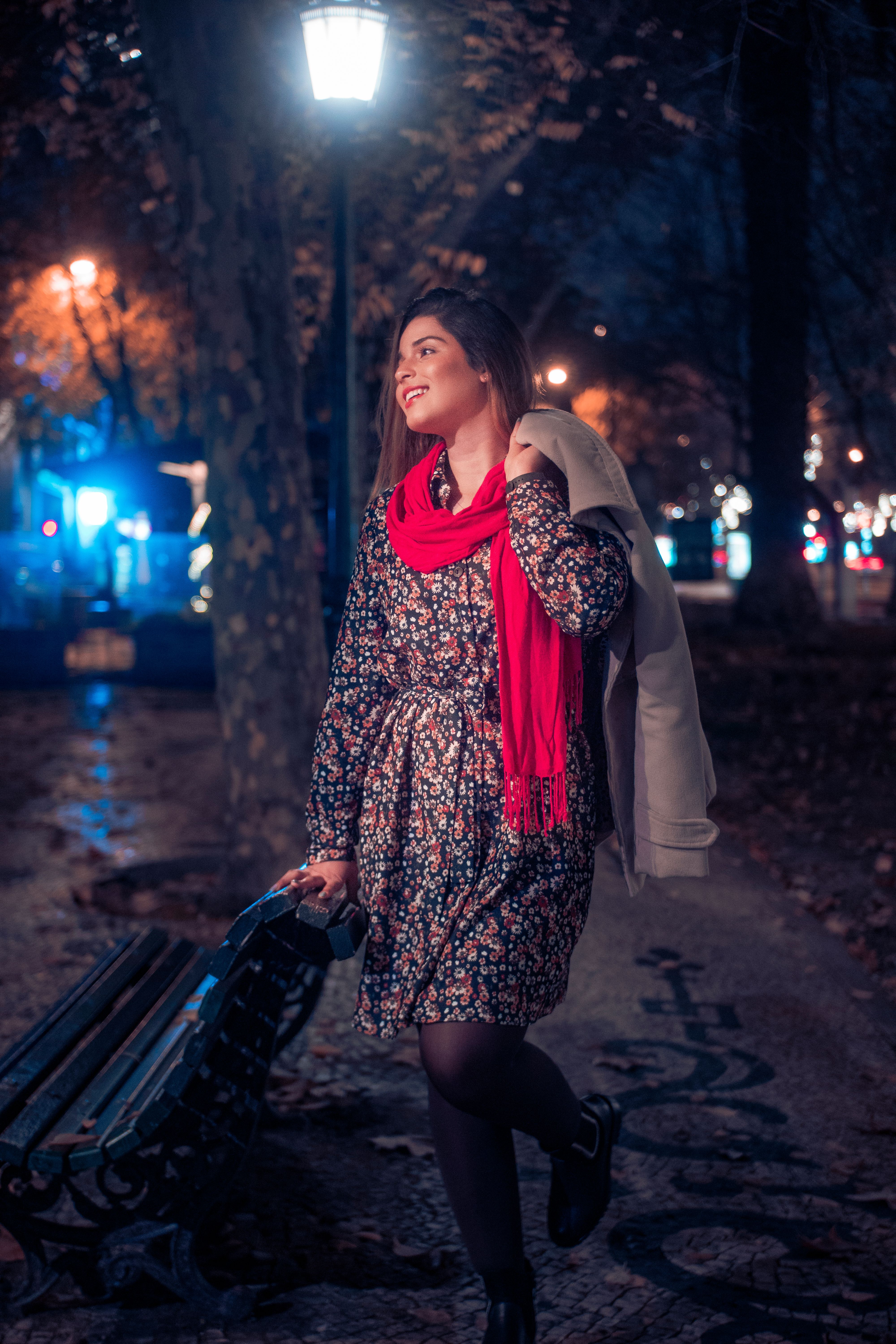 Woman in a Floral Dress Standing and Leaning on the Park Bench · Free ...
