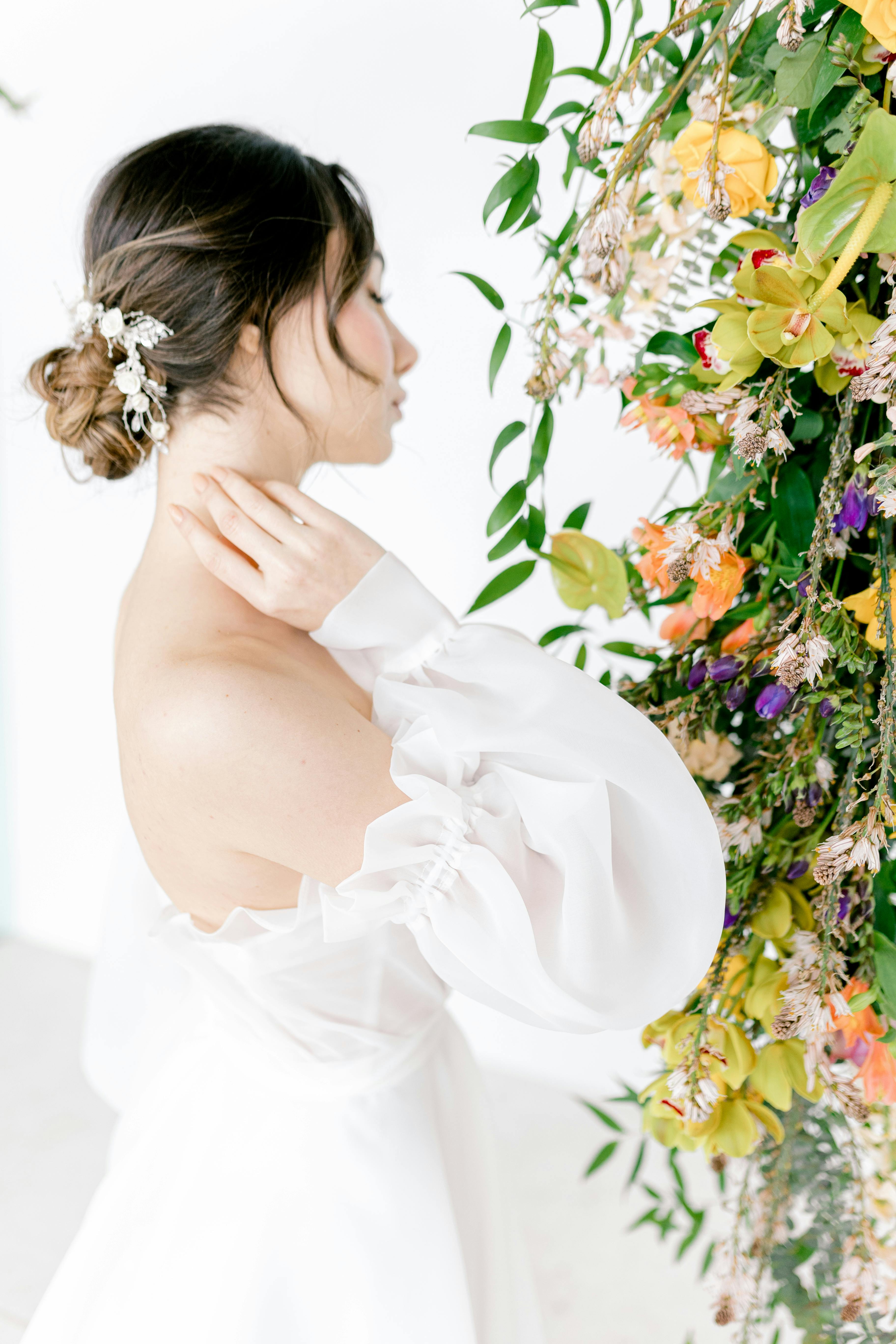 Bride in a Wedding Dress Standing by a Flower Arrangement · Free Stock ...