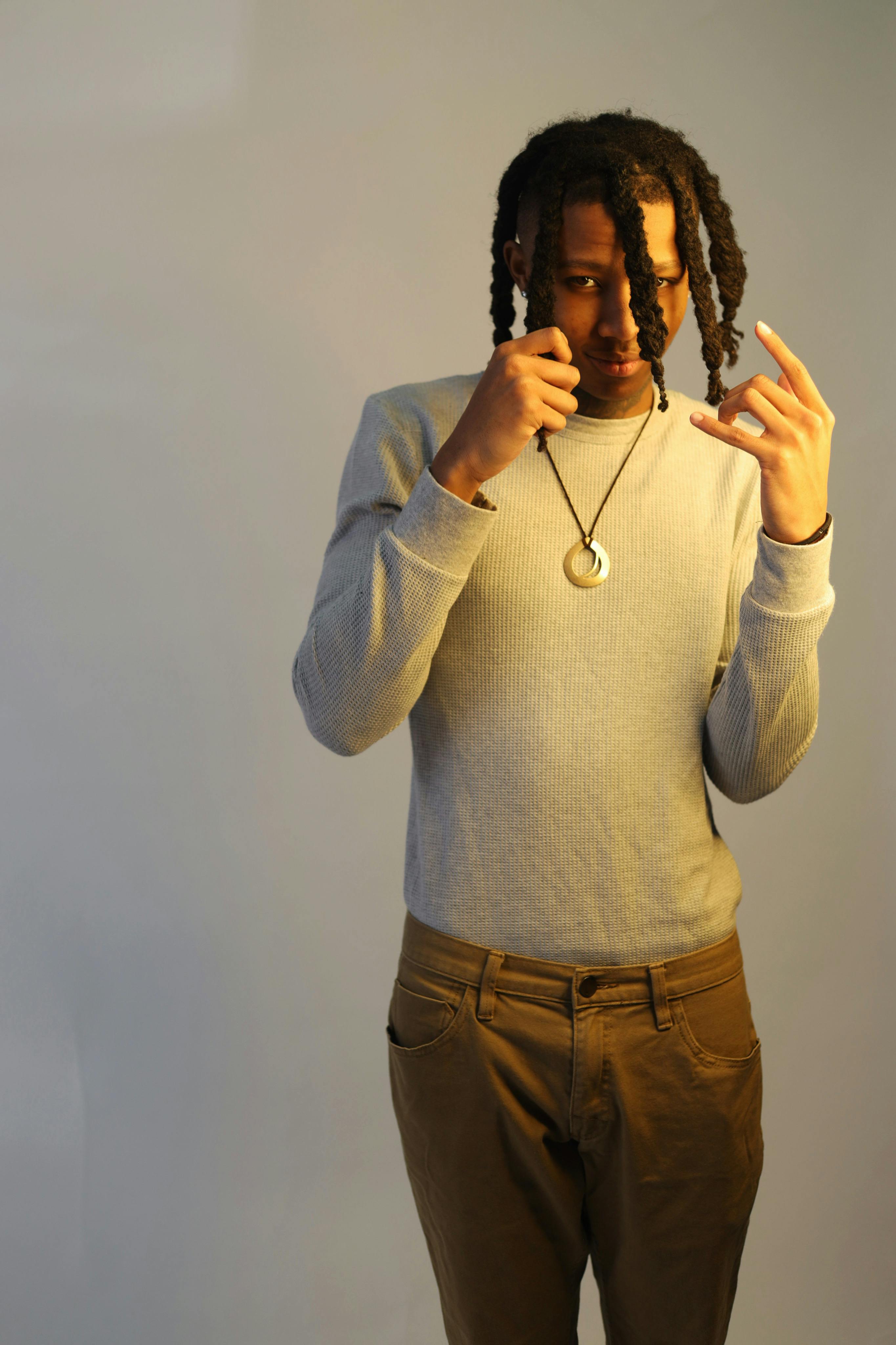 Standing in Spotlight Man Gesturing in Studio · Free Stock Photo