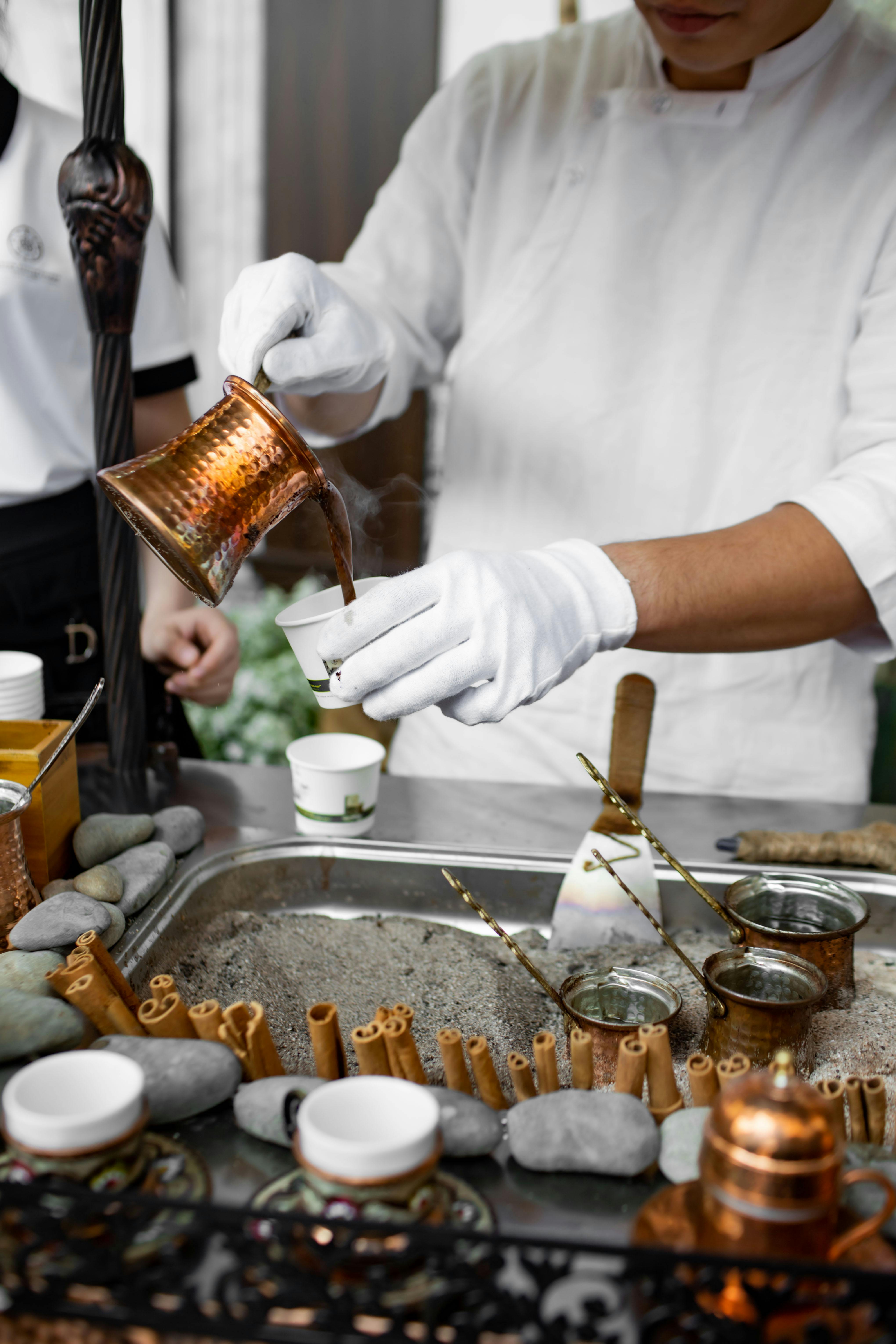 Man Making Traditional Coffee with Cinnamon · Free Stock Photo
