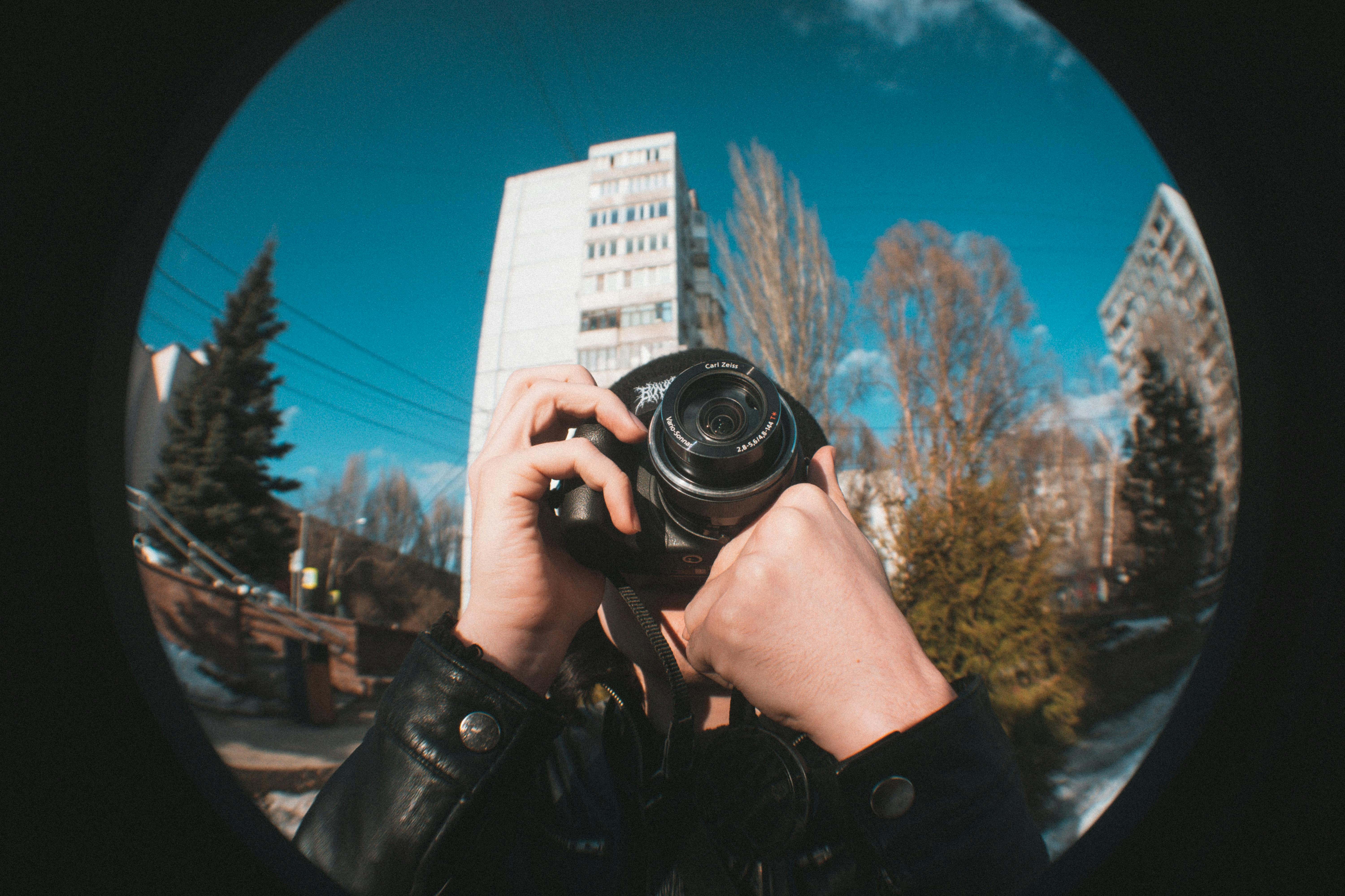 View in a Lens on Hands Holding a Camera · Free Stock Photo