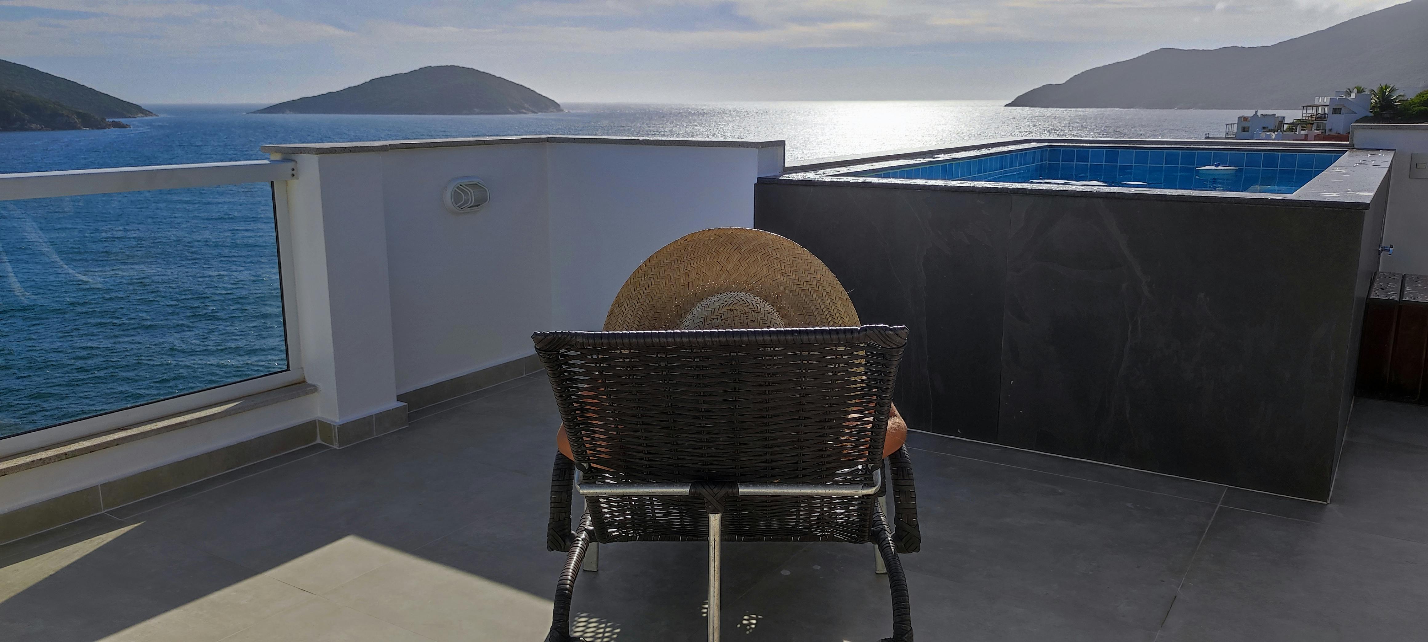 Woman Lying on a Sun Lounger and Tanning on a Terrace of a Villa by the ...