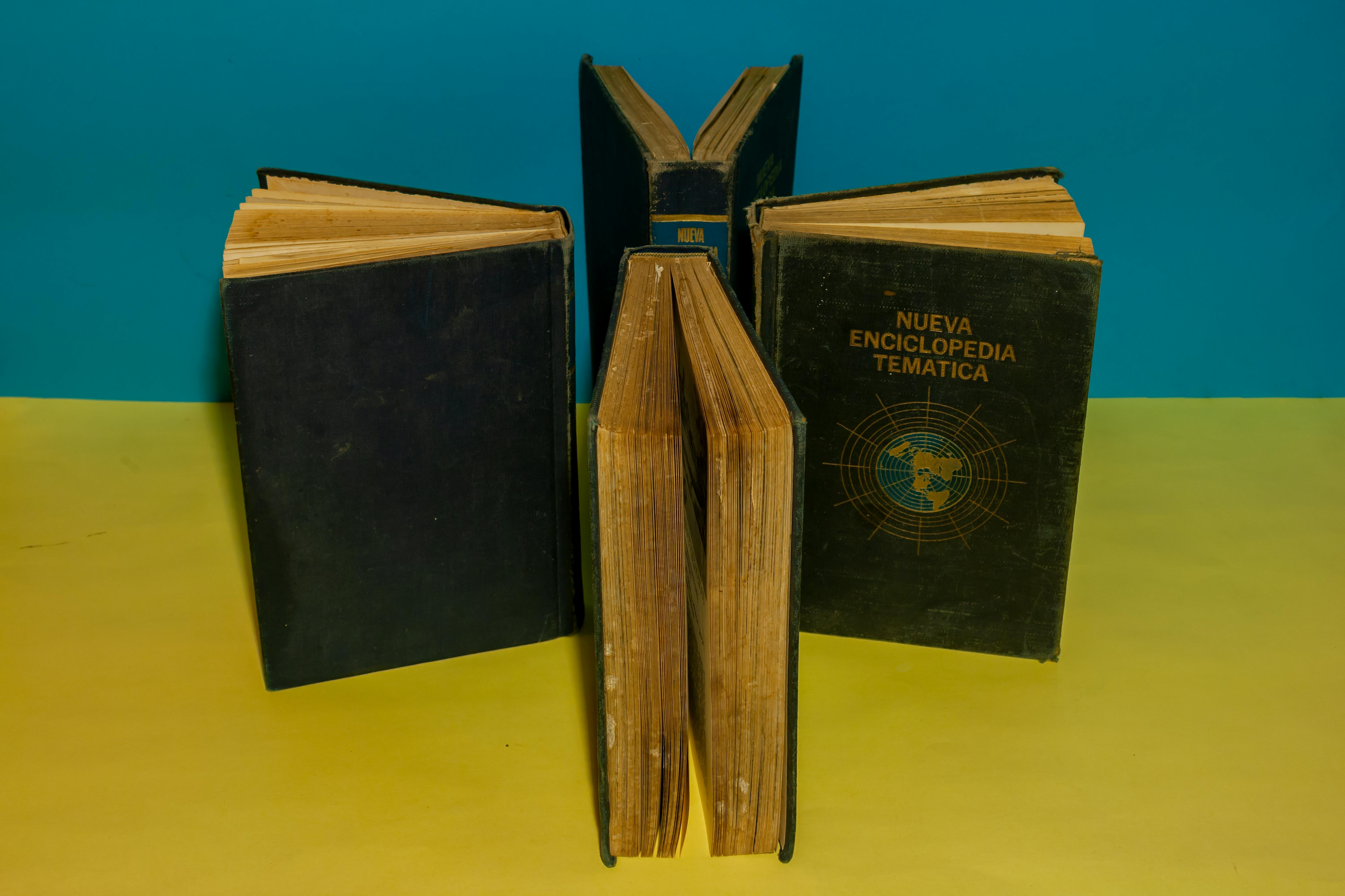 Old Geography Books Standing on Blue and Yellow Background · Free Stock ...