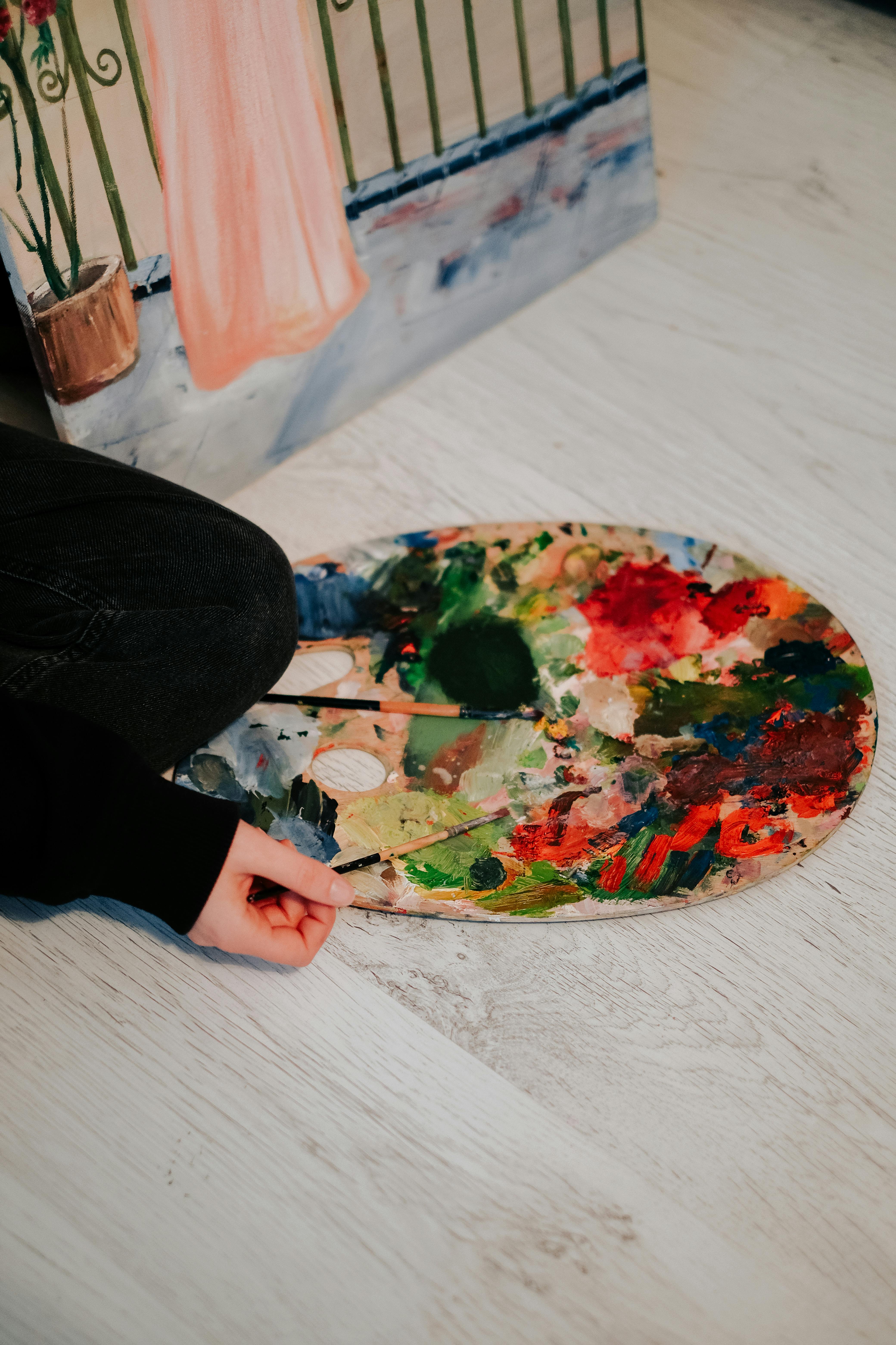 Artists Mixing Paint in the Color Palette · Free Stock Photo