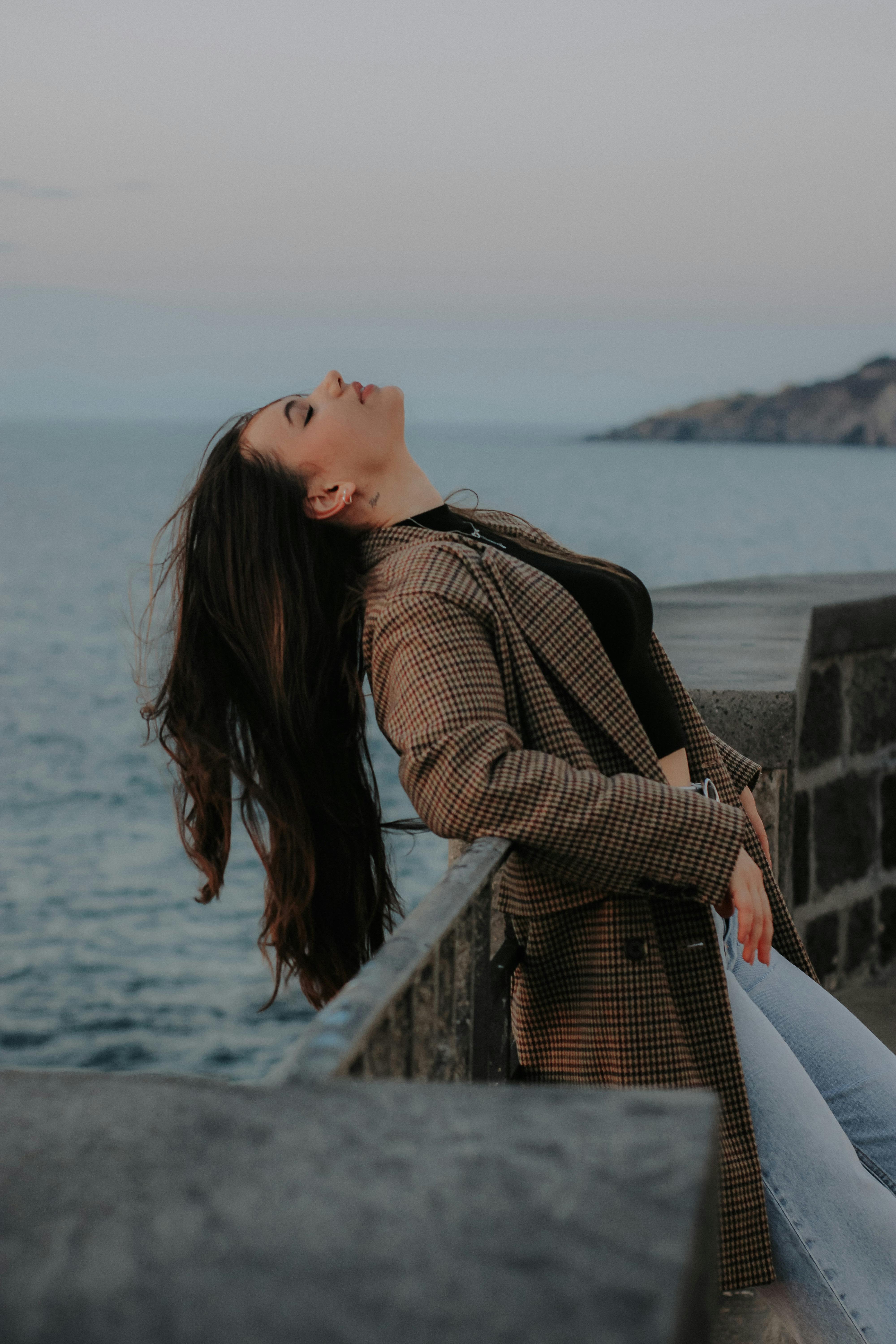 Woman Leaning on Railing and Posing · Free Stock Photo