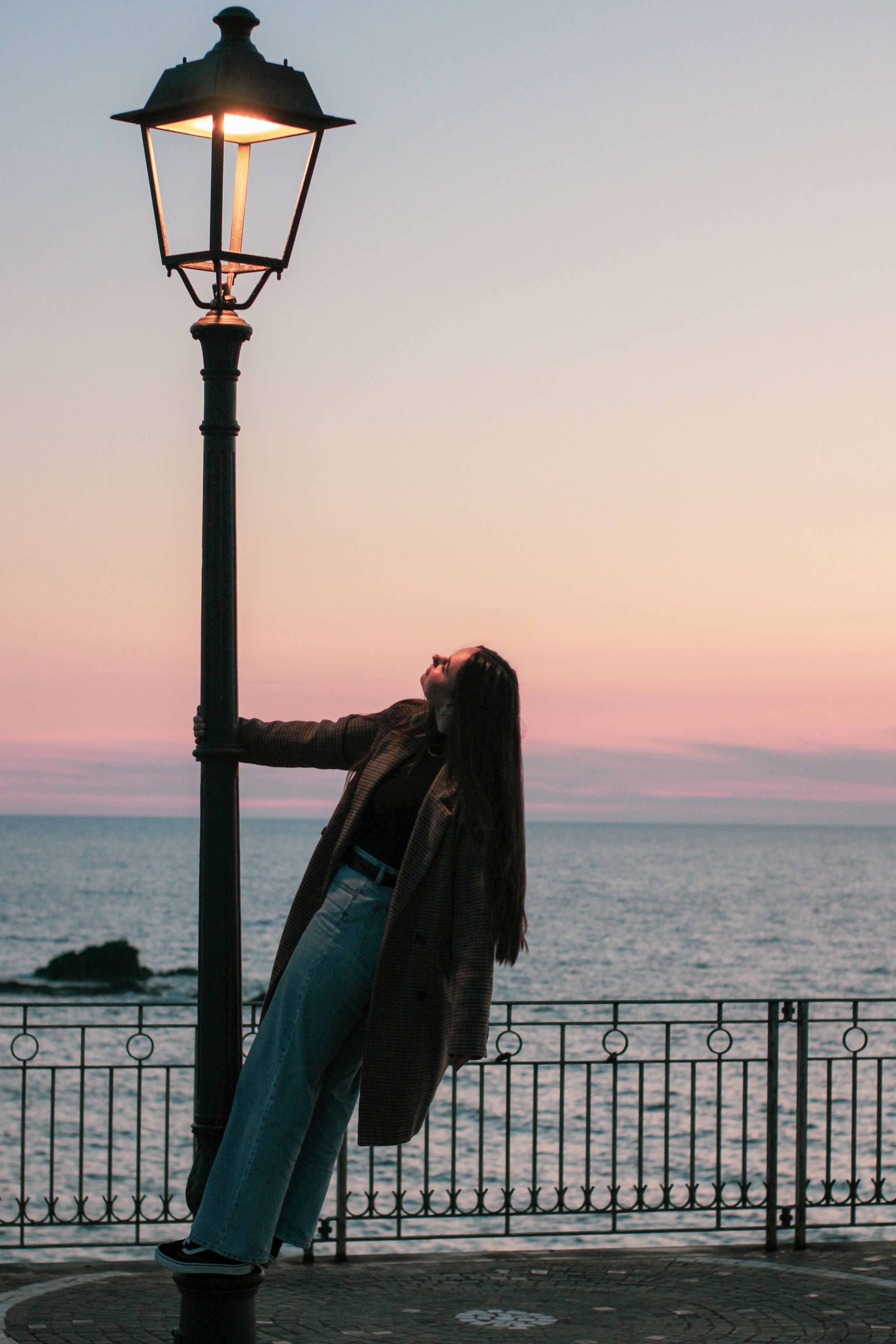 Woman Posing by Street Lamp at Dusk · Free Stock Photo